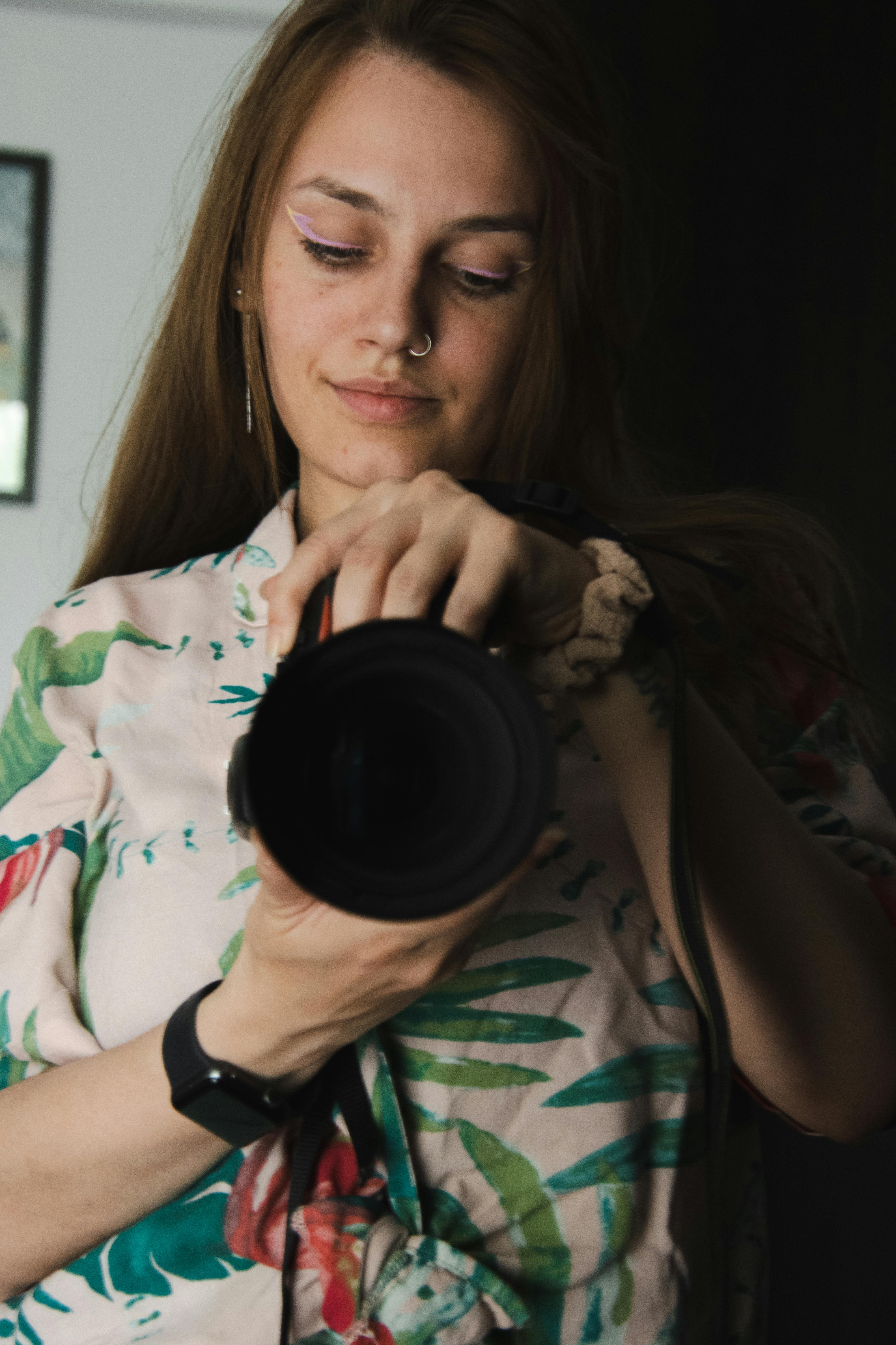 Beautiful Woman Using a Camera · Free Stock Photo