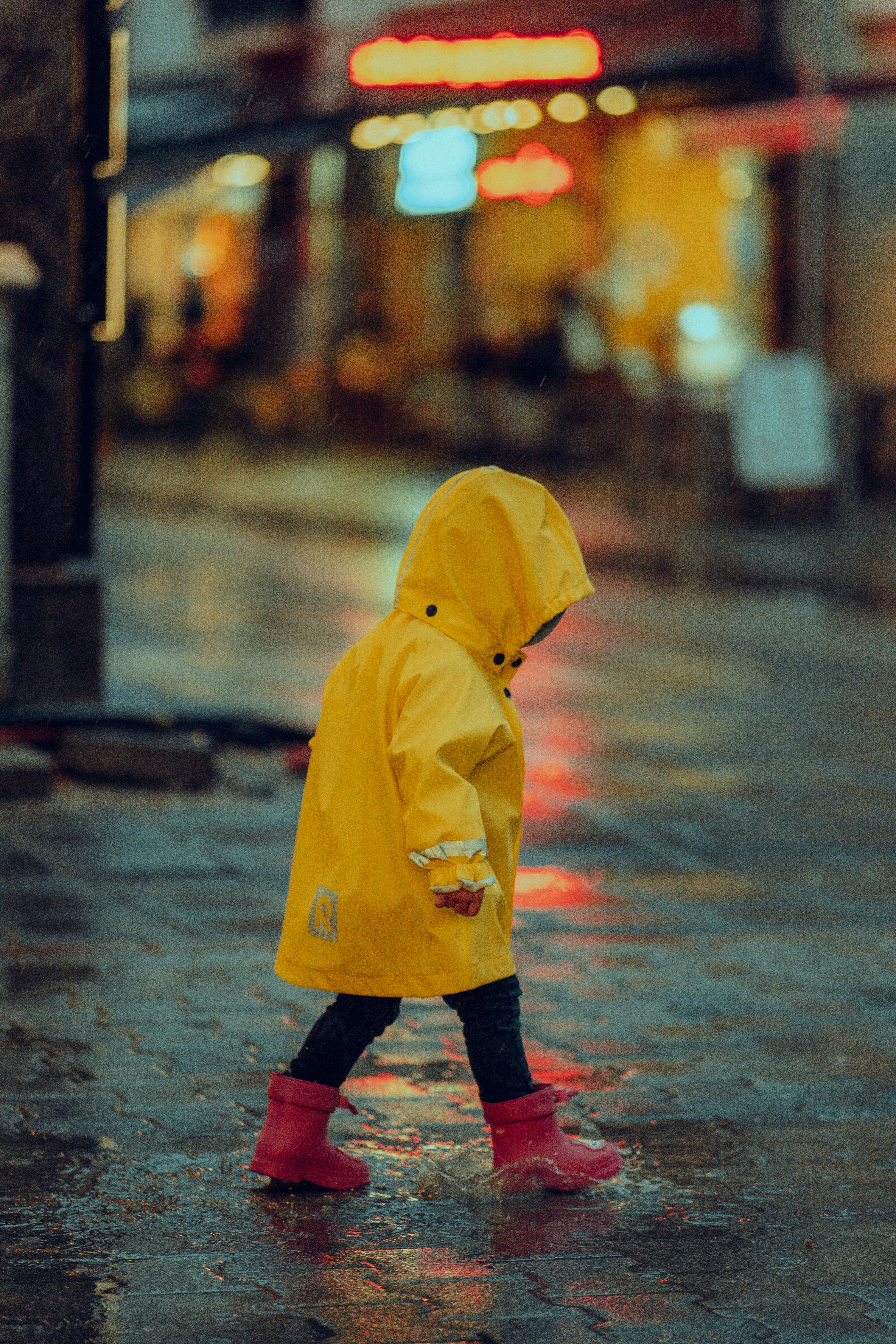 Kid Stepping on a Puddle · Free Stock Photo