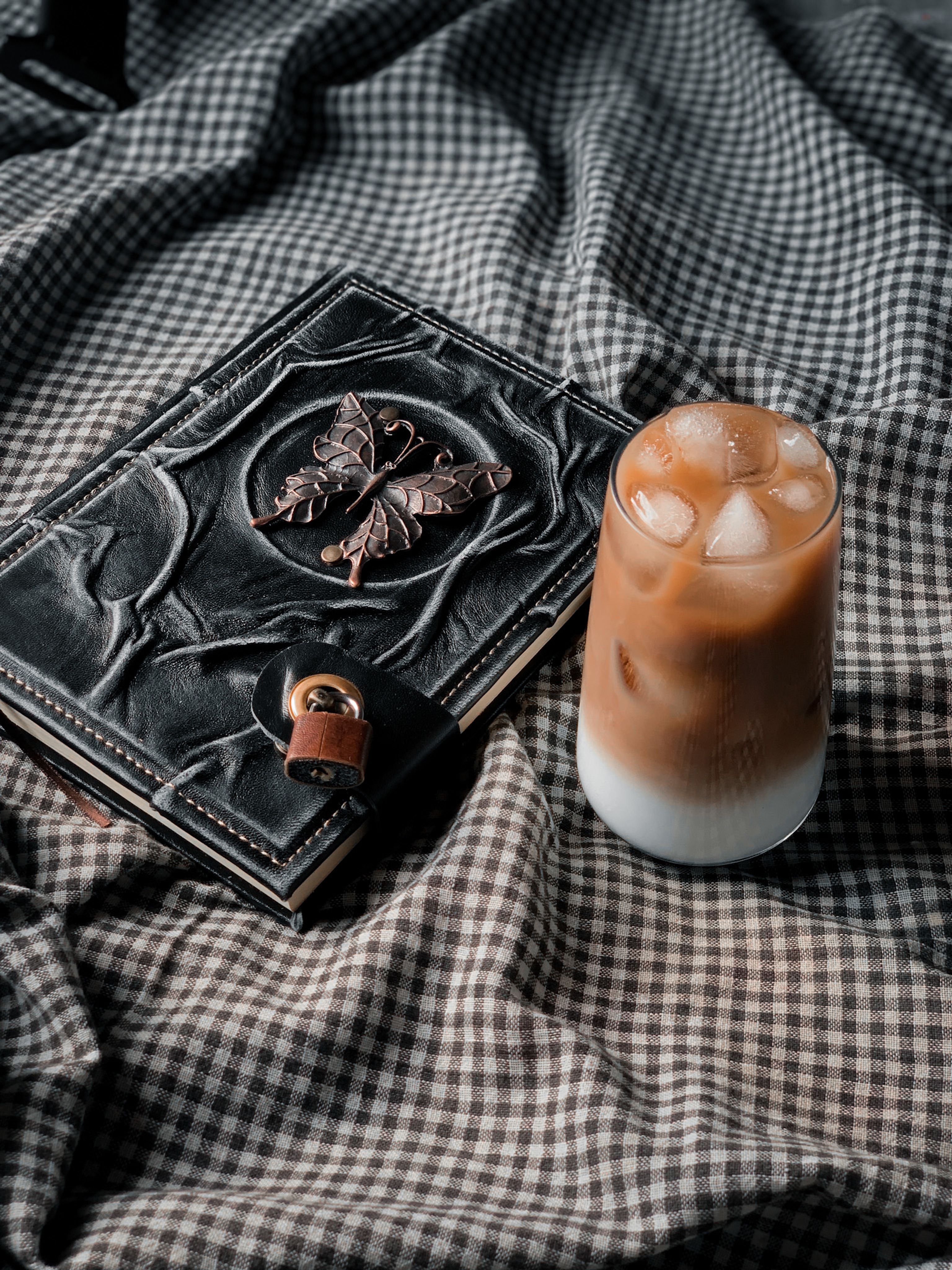 Iced Coffee Beside the Black Notebook · Free Stock Photo