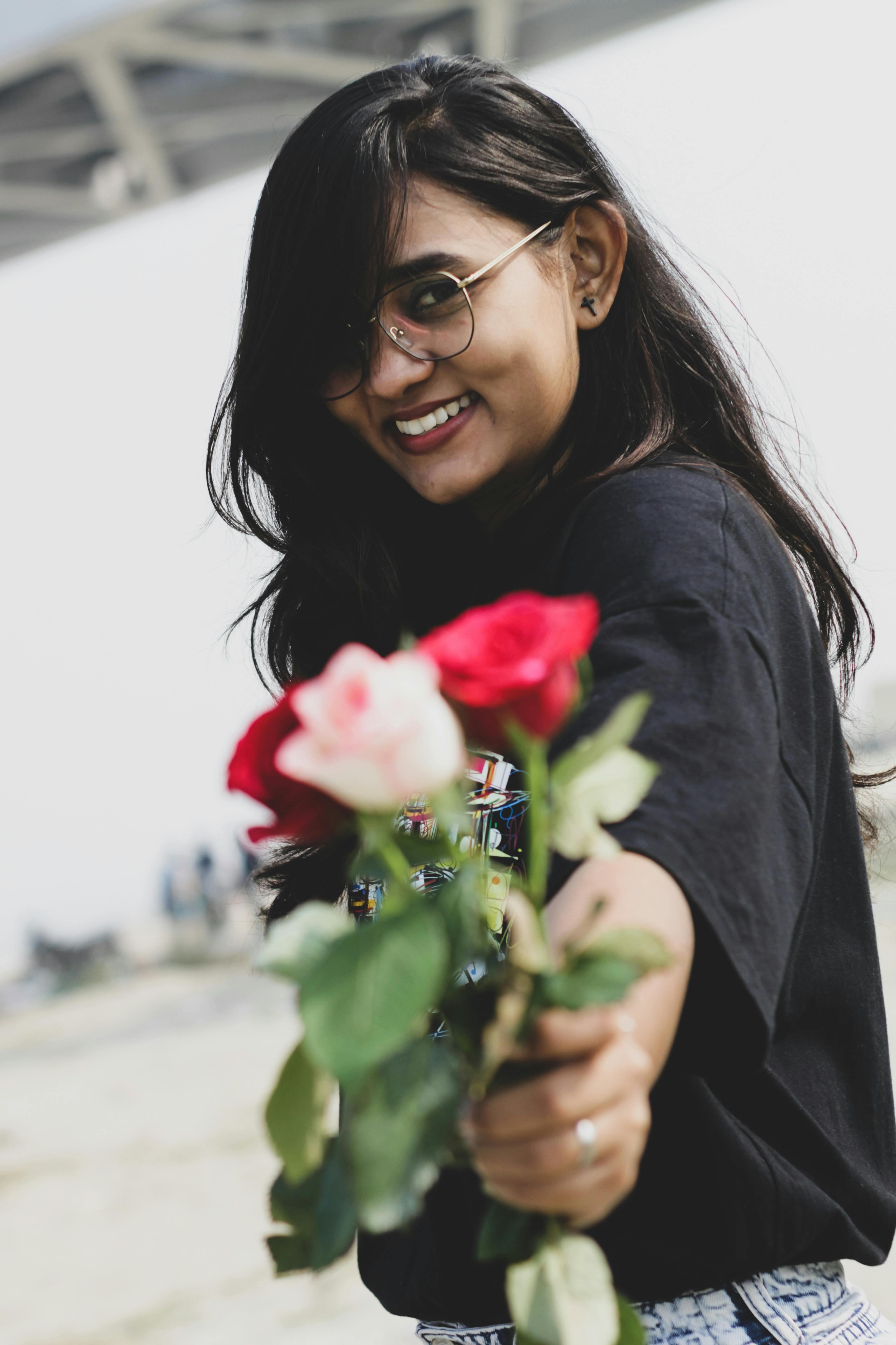 A Woman Holding Roses · Free Stock Photo