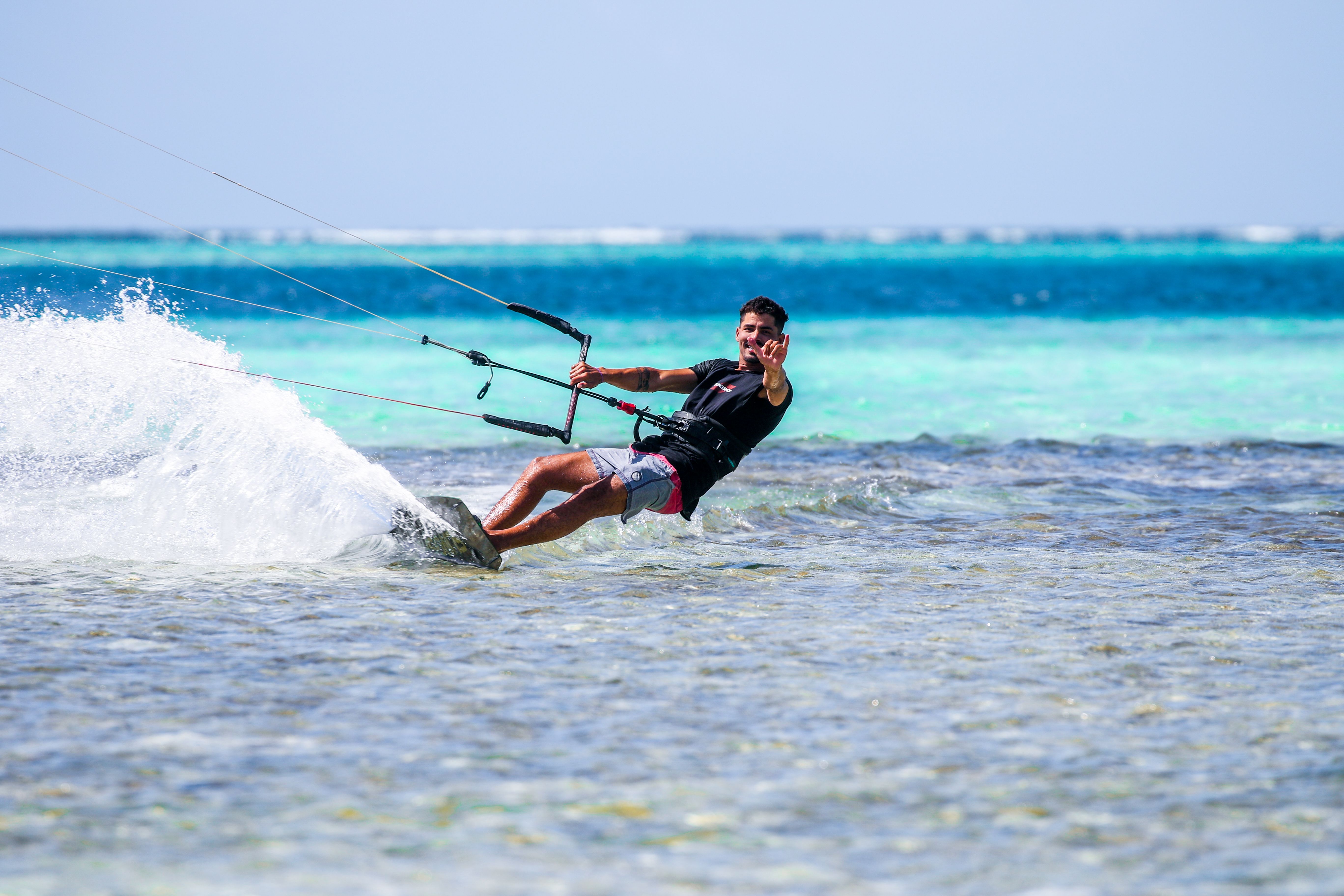 A Man Doing the Shaka Sign while Kitesurfing · Free Stock Photo