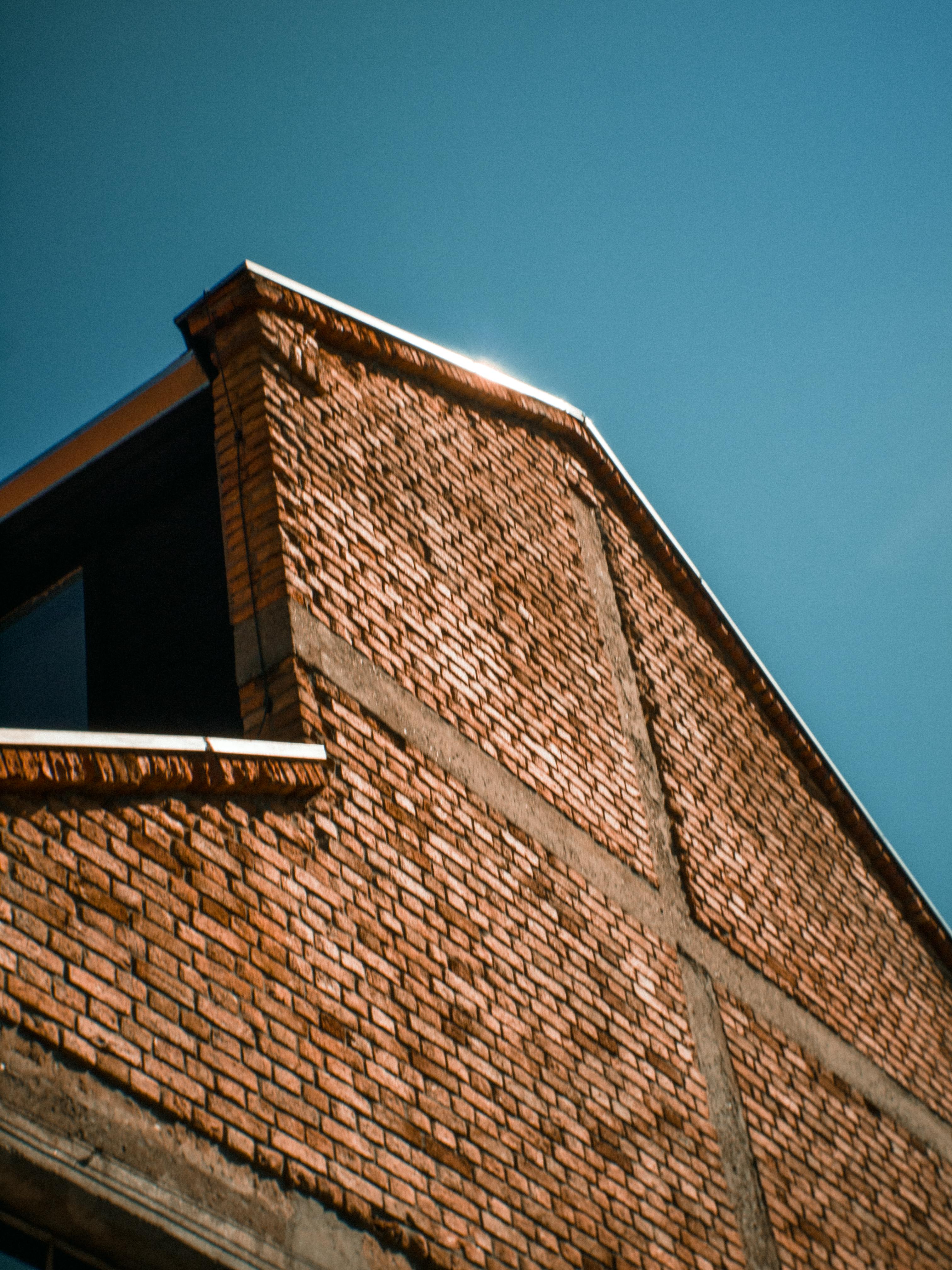 Creative Brick Building with Geometric Drawings on Blue Sky · Free ...