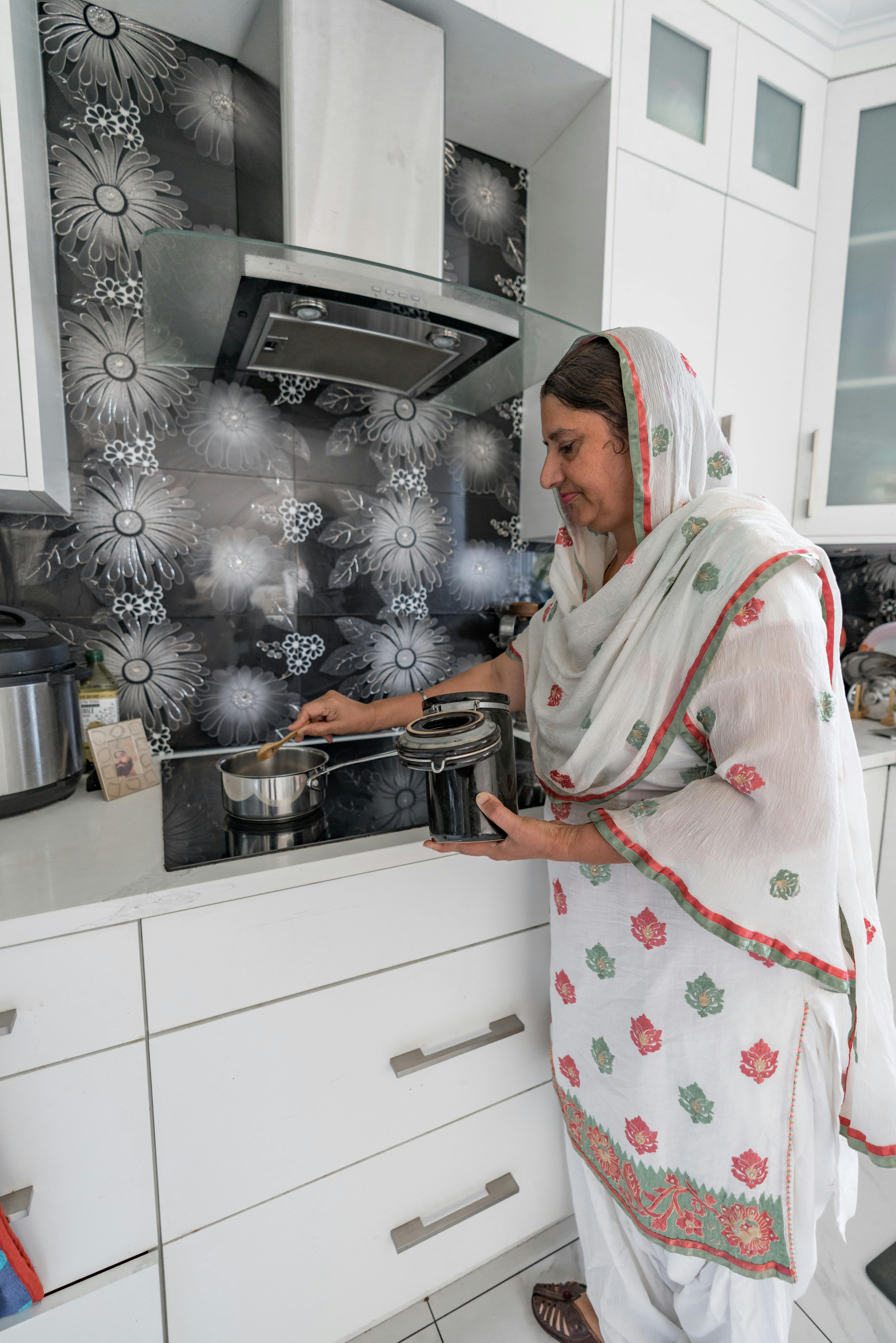 Shirtless Young Man Cooking on Kitchen Stove · Free Stock Photo