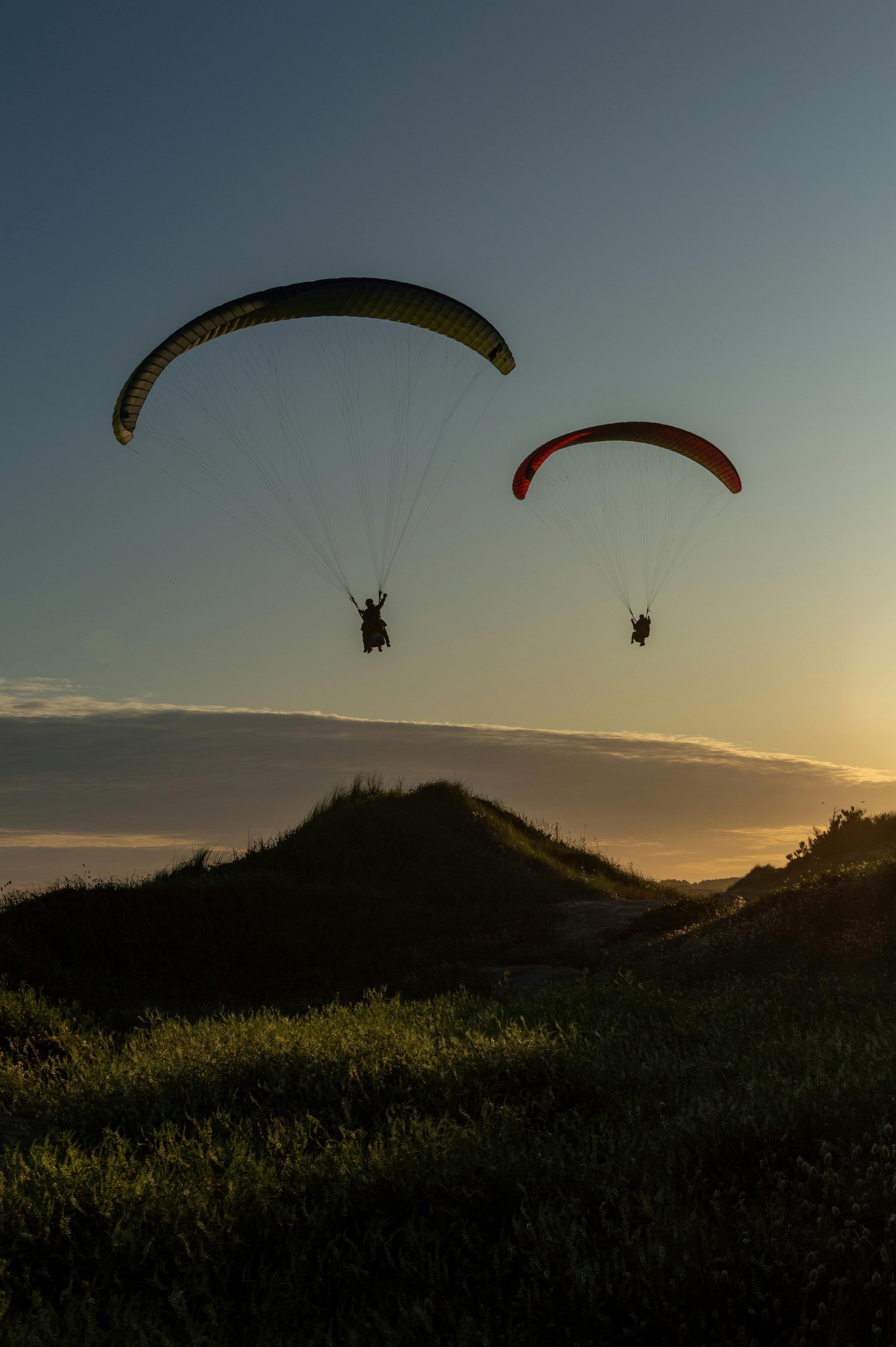 Person Riding Blue Parachute over Snow Covered Mountain · Free Stock Photo