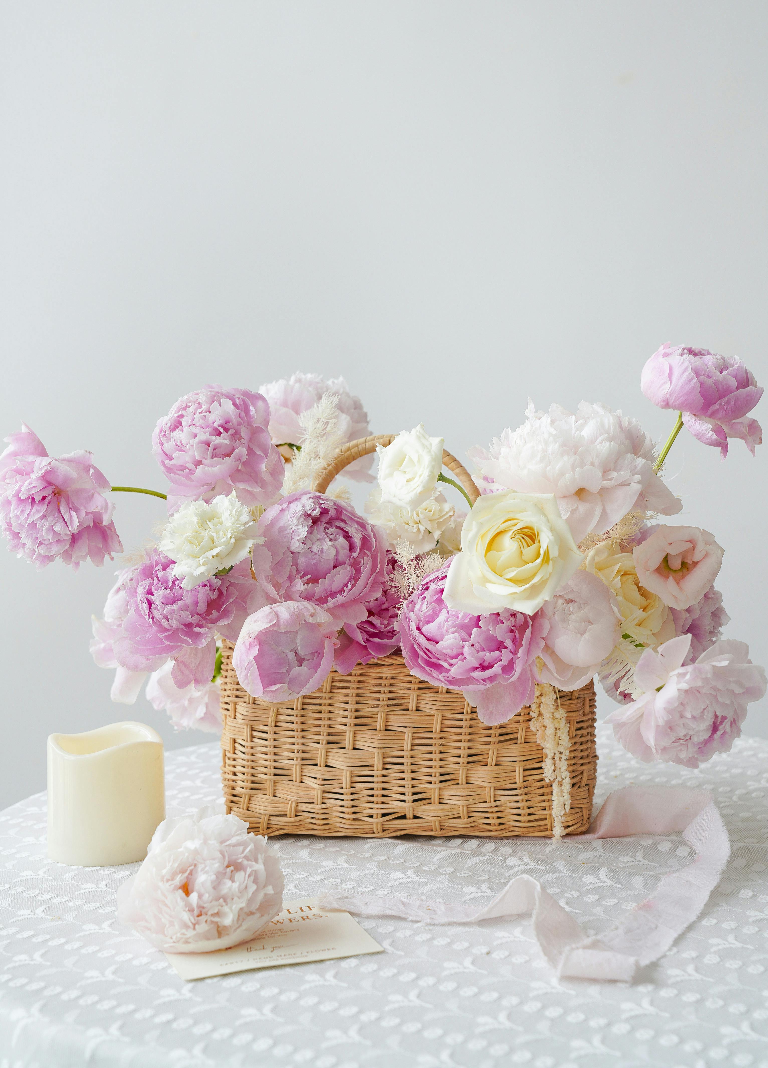 Delicate Flower Arrangement in Basket · Free Stock Photo