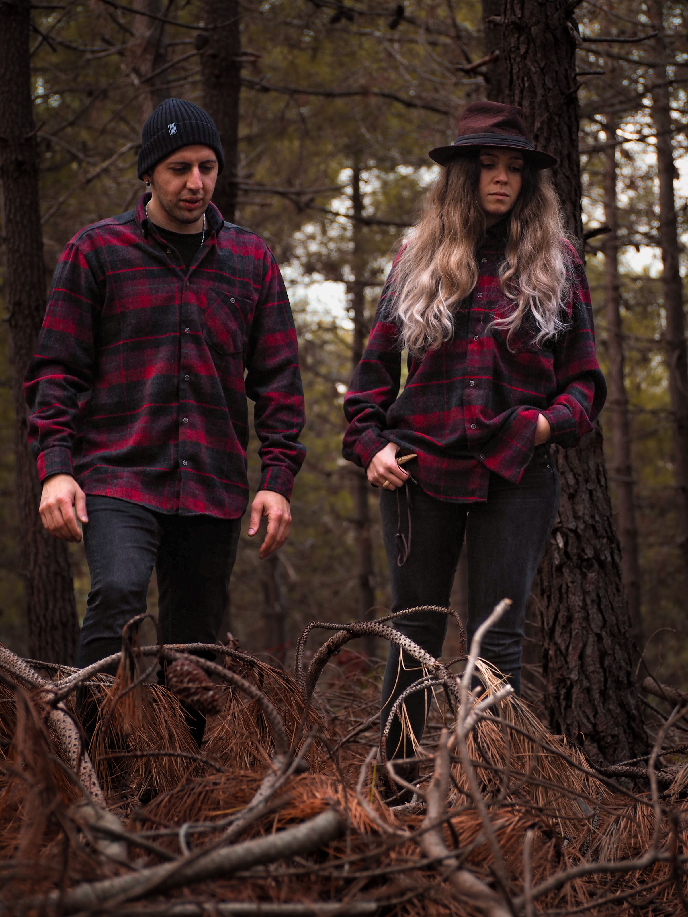 Man and Woman in Matching Checkered Shirts Walking in a Forest in ...