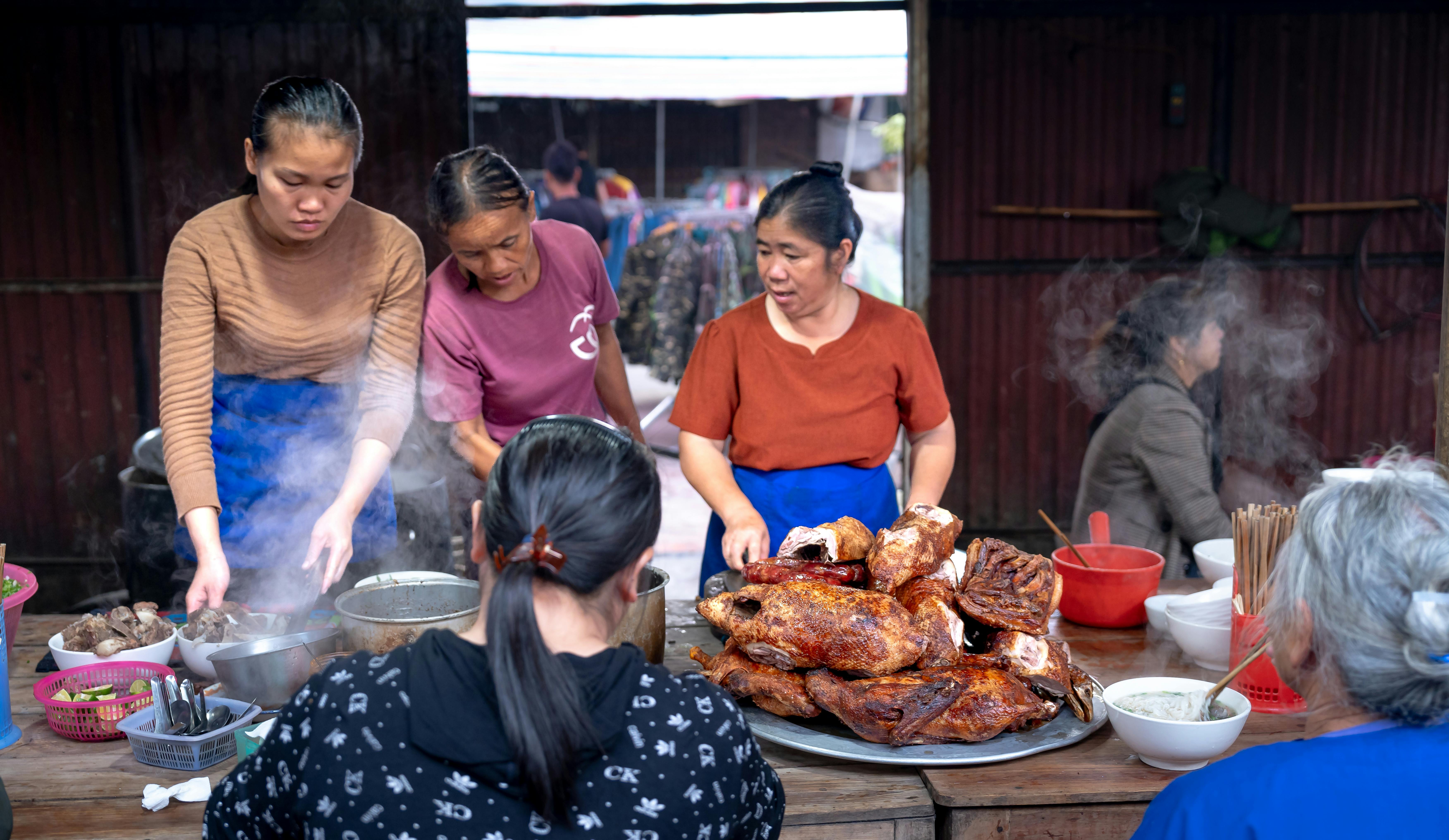 Women Cooking Traditional Food on a Market · Free Stock Photo