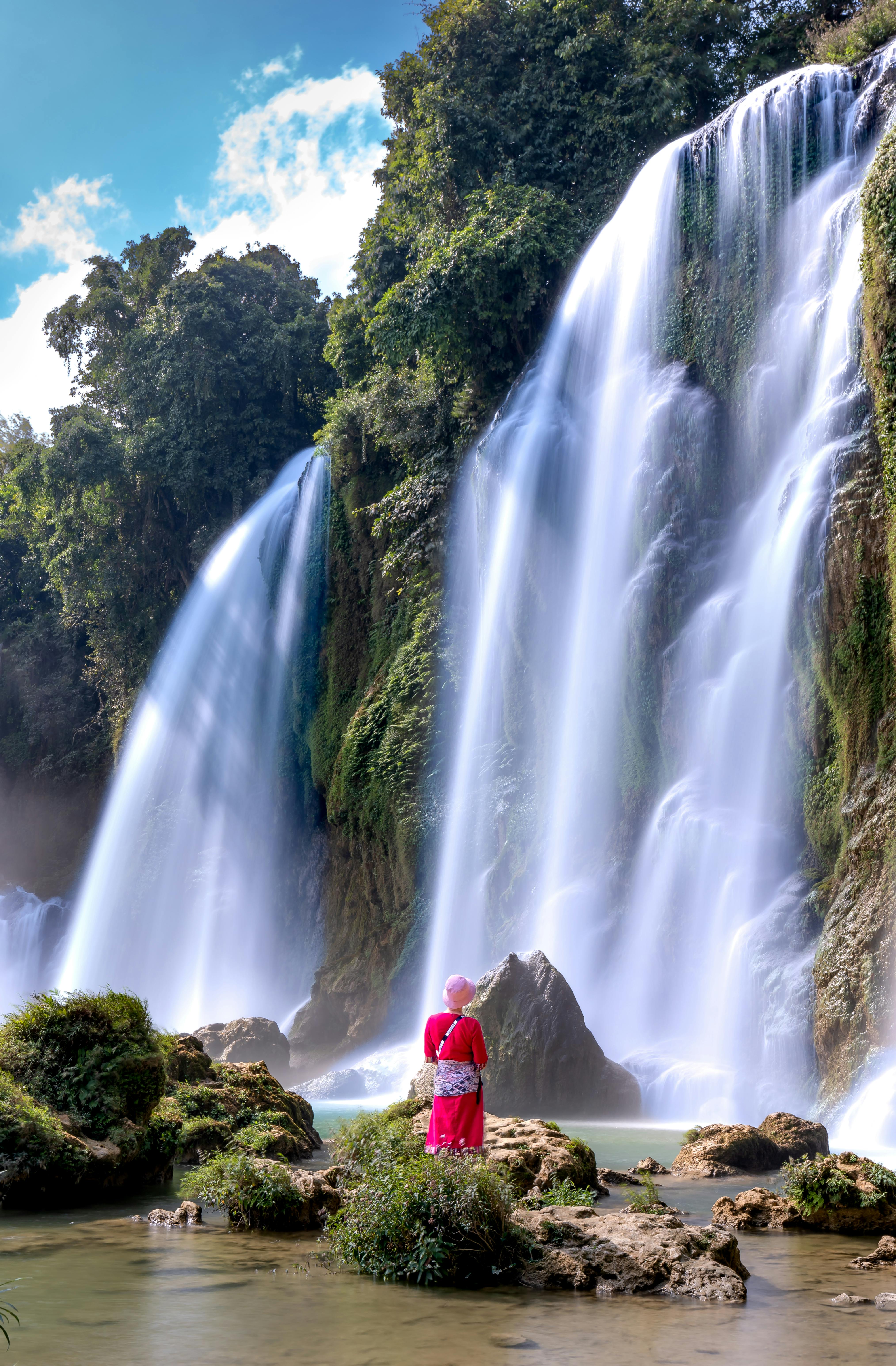 A Person in Red Dress Standing beside the Waterfalls · Free Stock Photo