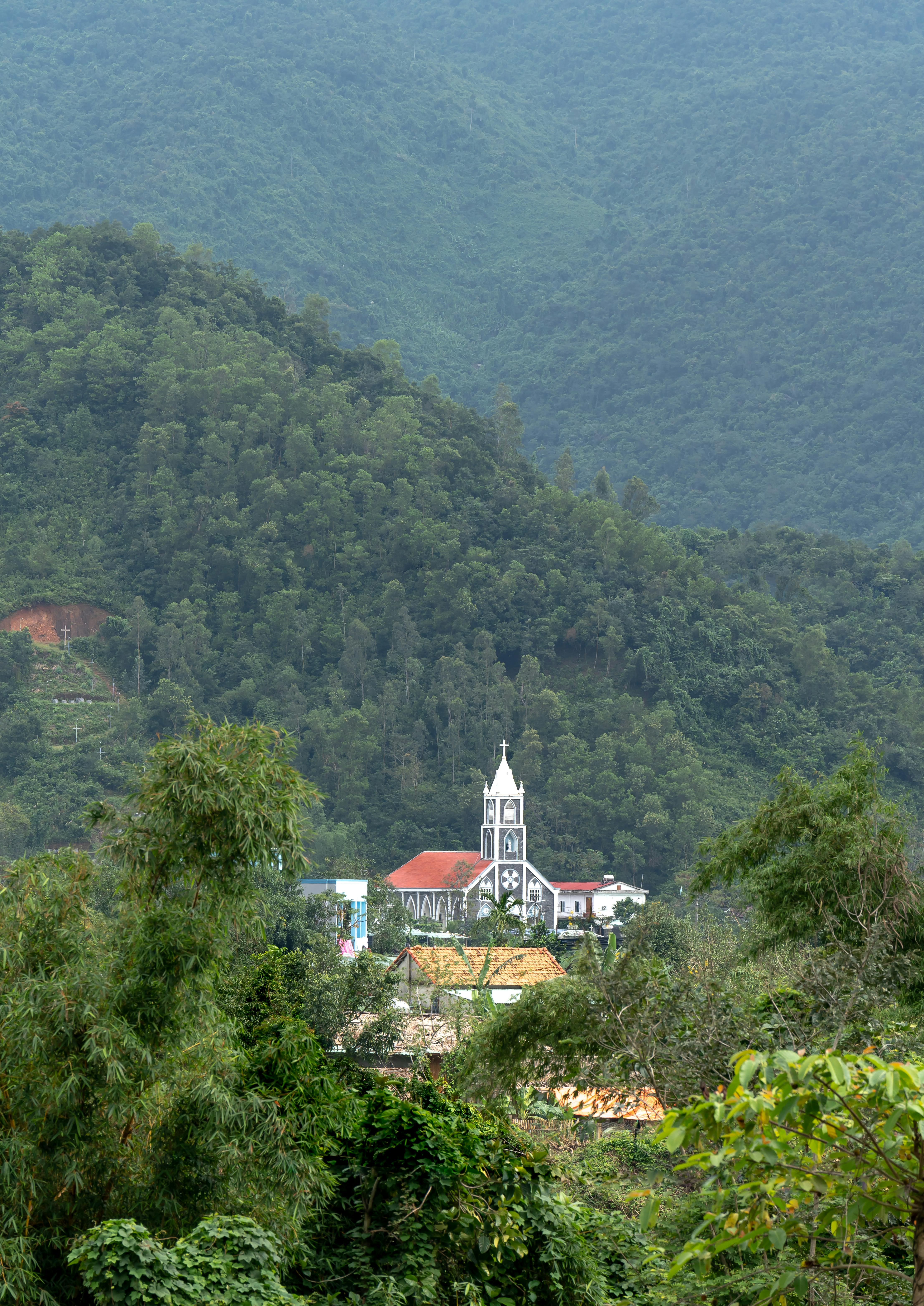 Mountains and Forest with a Church in the Valley · Free Stock Photo