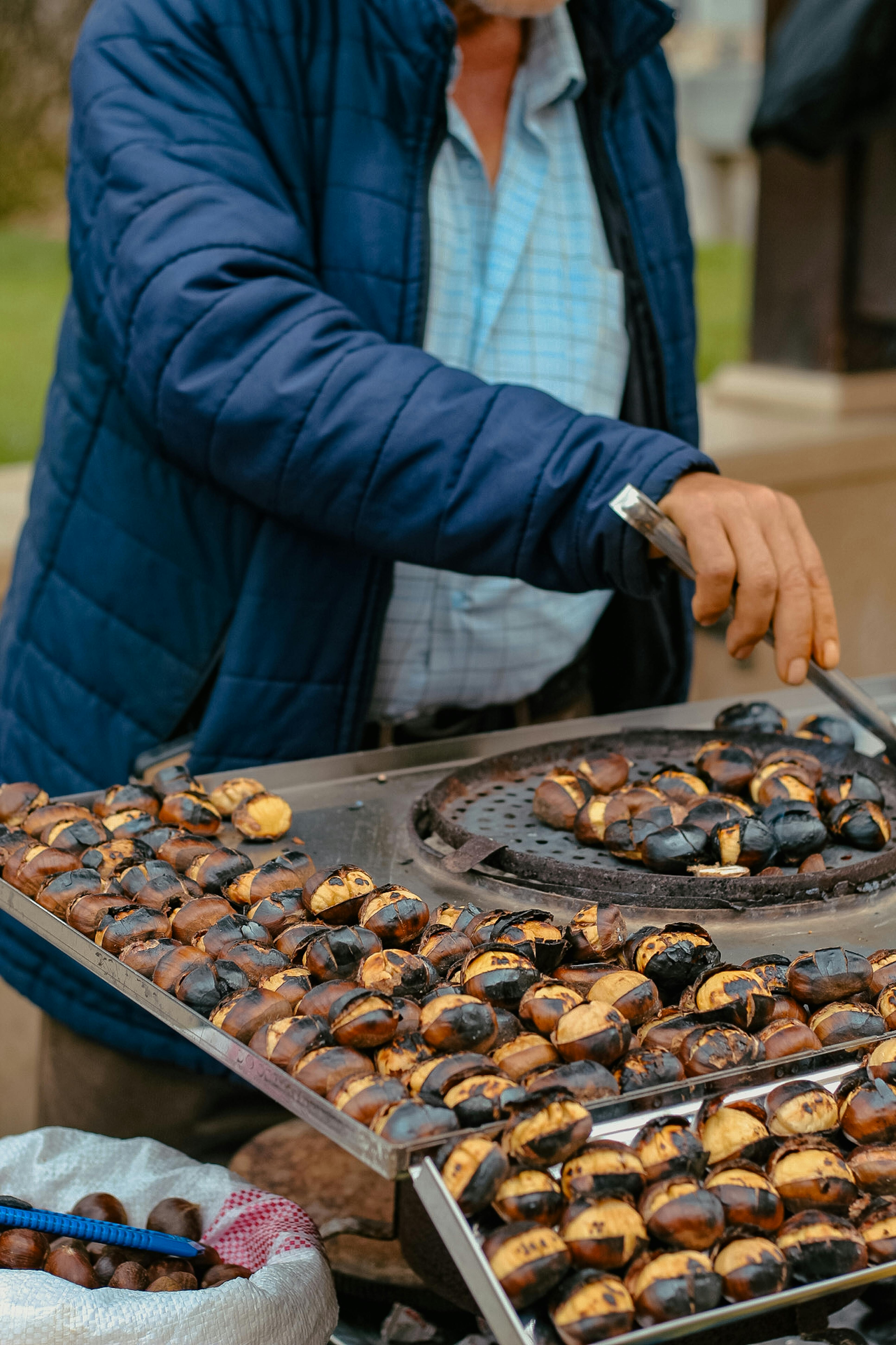 Man Cooking a Bunch of Chestnuts · Free Stock Photo