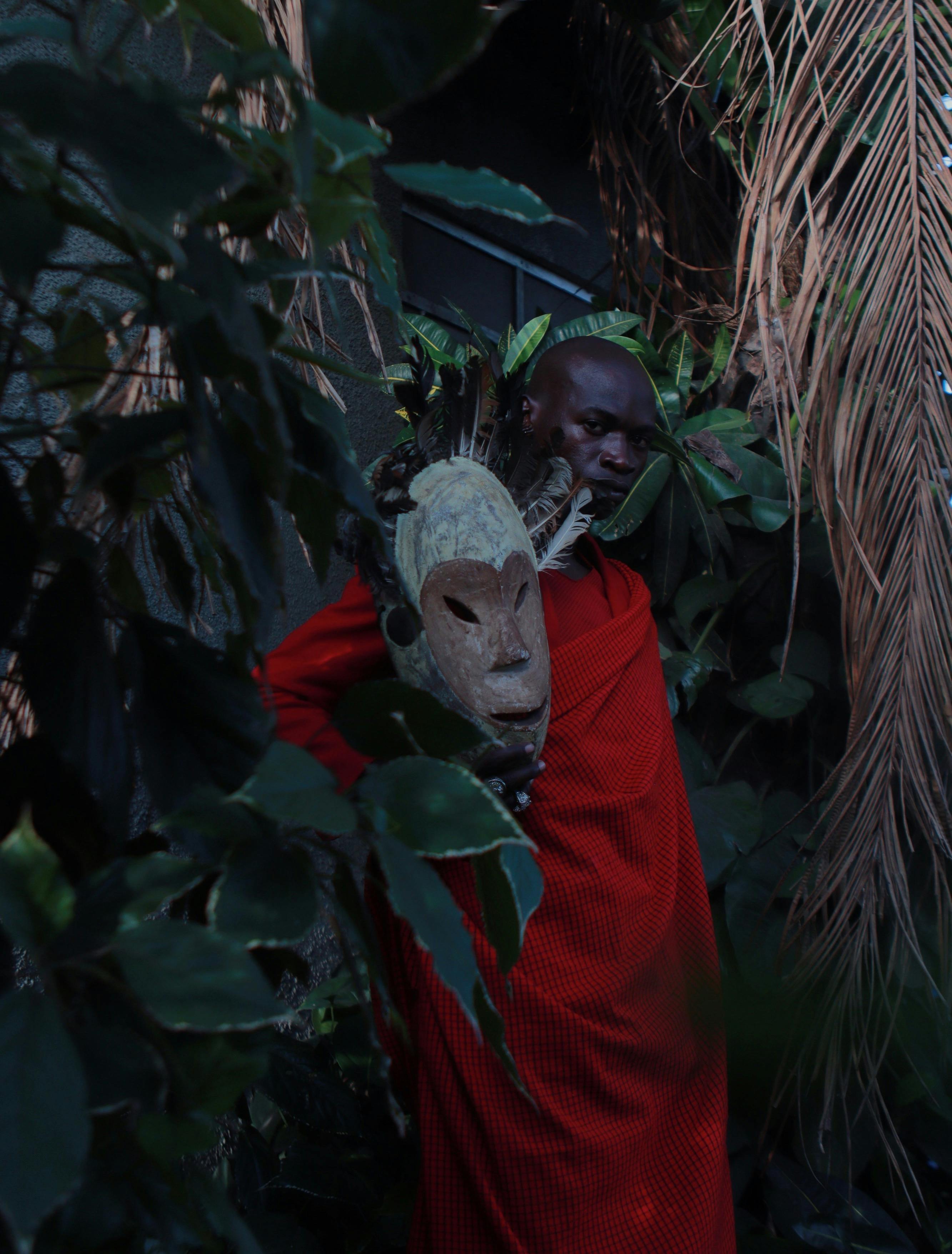 Man in Red Robe Holding Wooden Mask · Free Stock Photo