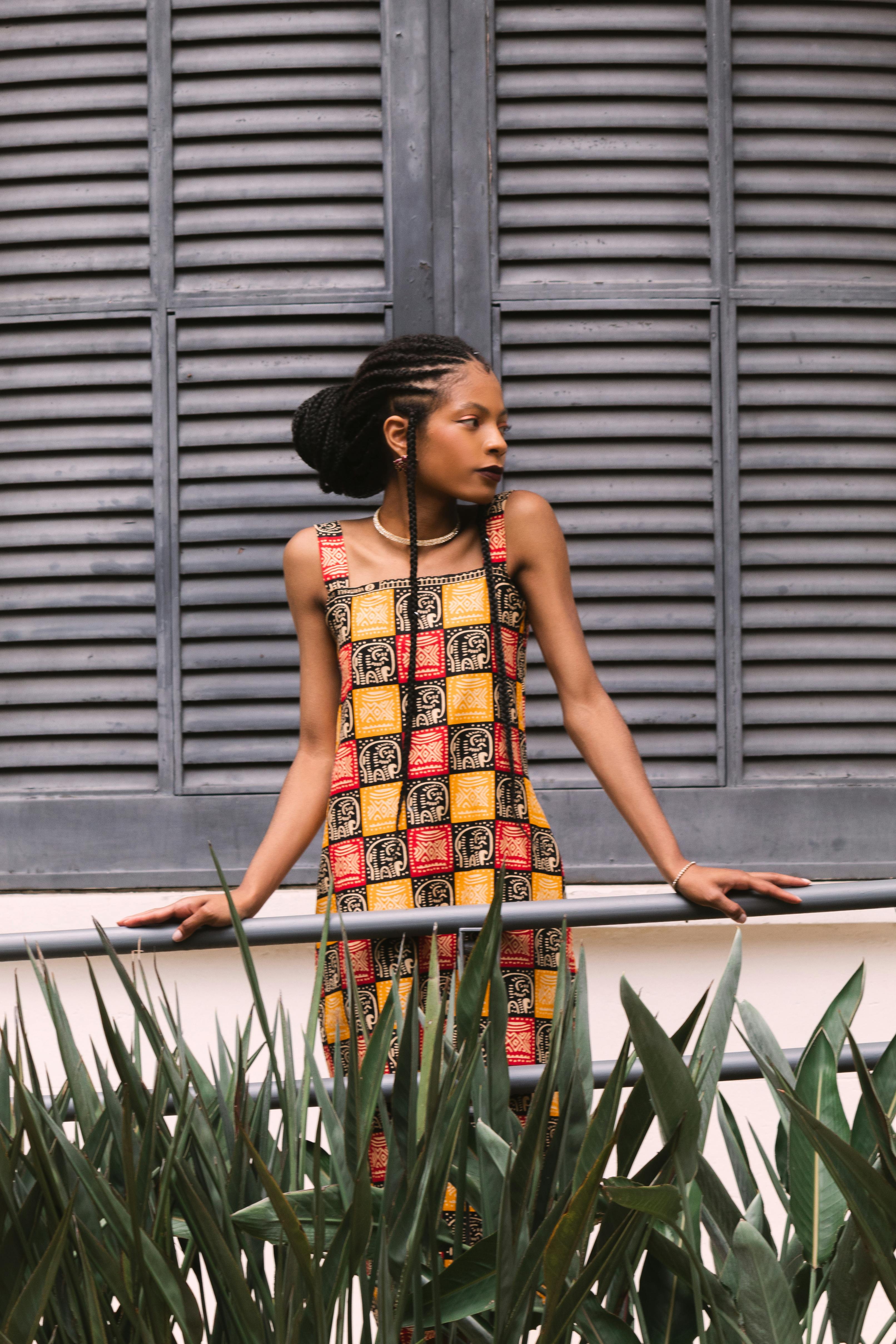 Braided Hair Woman Standing near the Metal Railing · Free Stock Photo