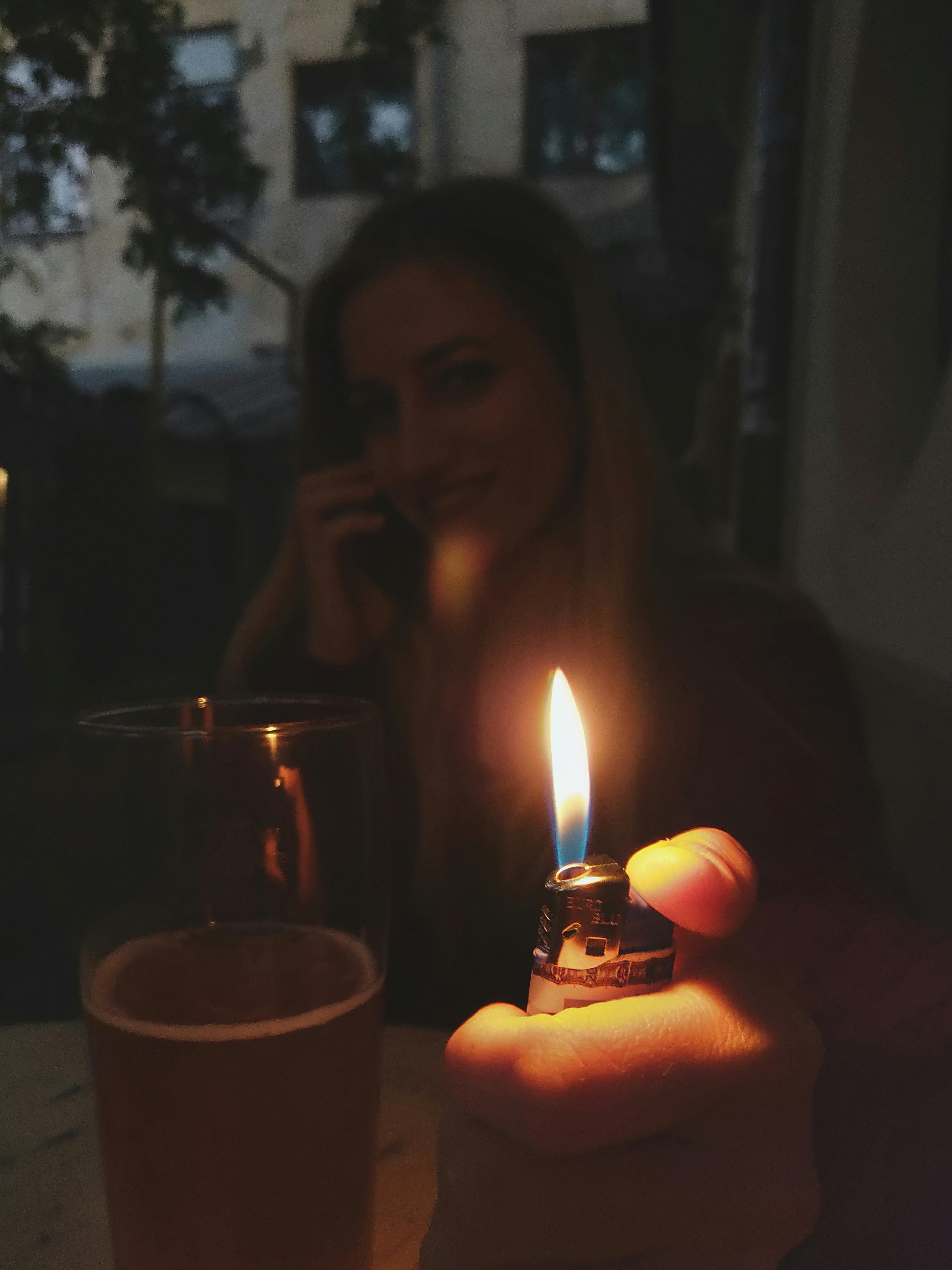 Woman Holding Lit Lighter · Free Stock Photo Woman Holding Lit Lighter · Free Stock Photo