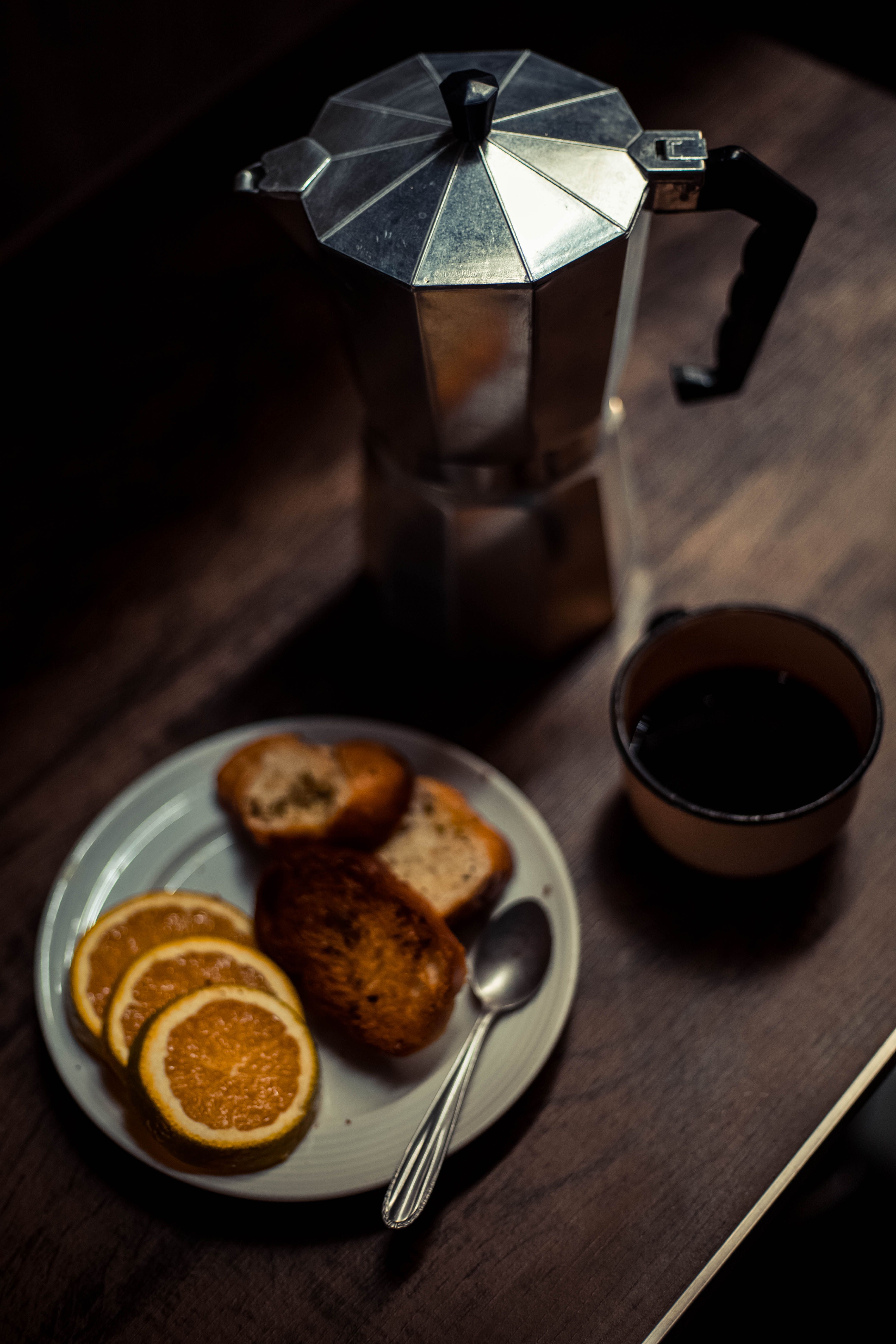 A Moka Pot Beside a Plate with Bread · Free Stock Photo