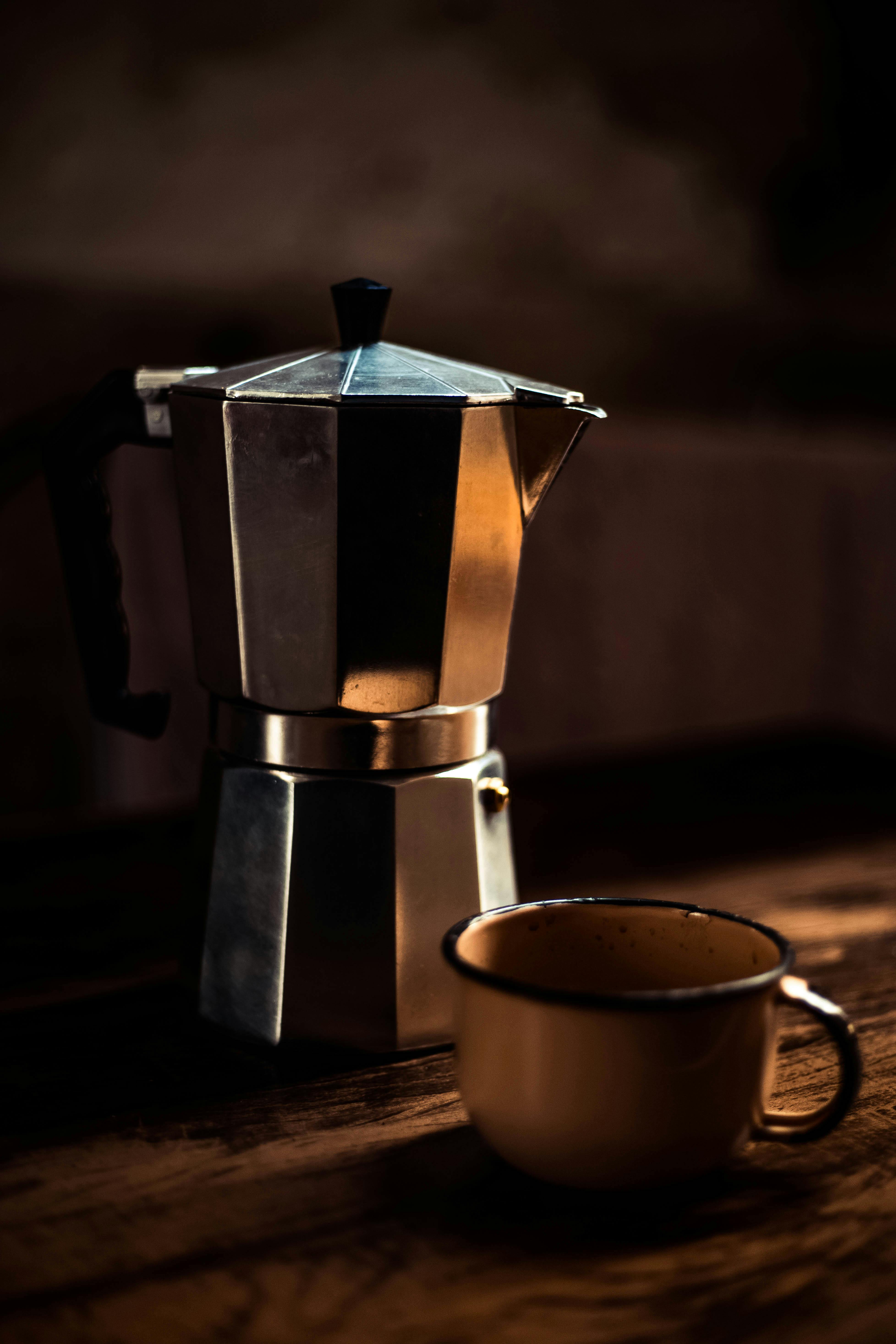 Close-Up Photograph of a Moka Pot Beside a Cup · Free Stock Photo