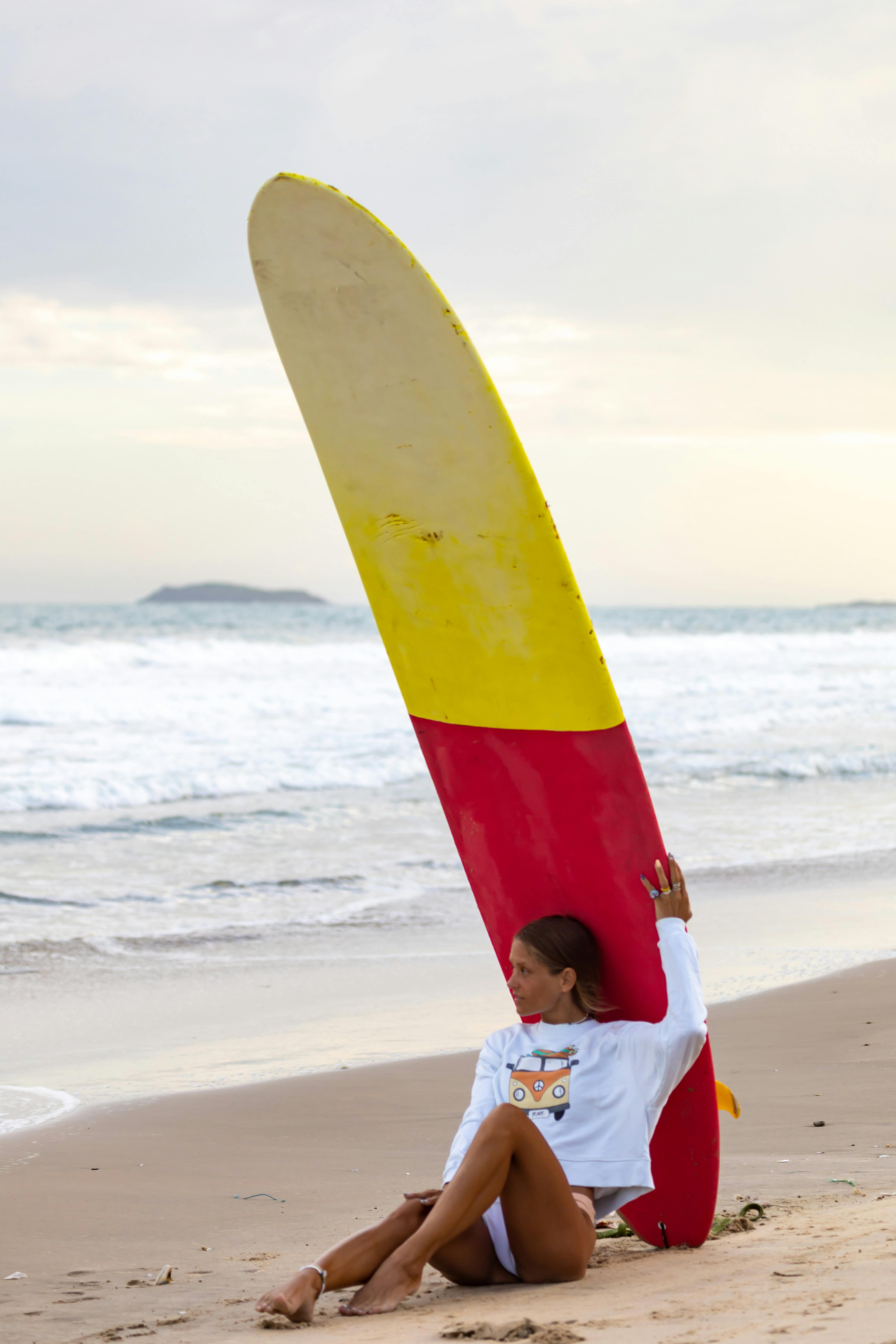 A Surfer Sitting on the Shore · Free Stock Photo