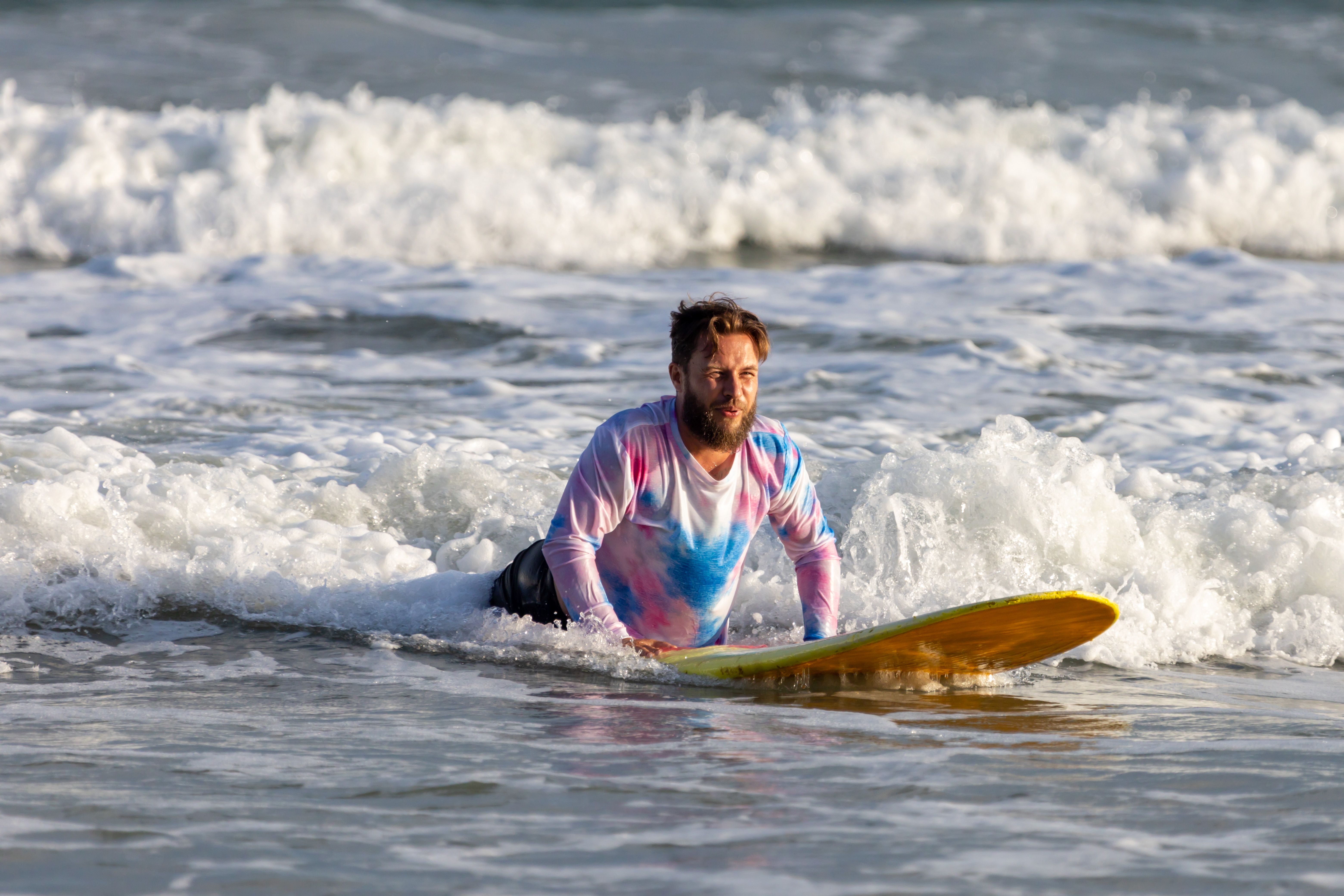 A Bearded Man on a Surfboard · Free Stock Photo