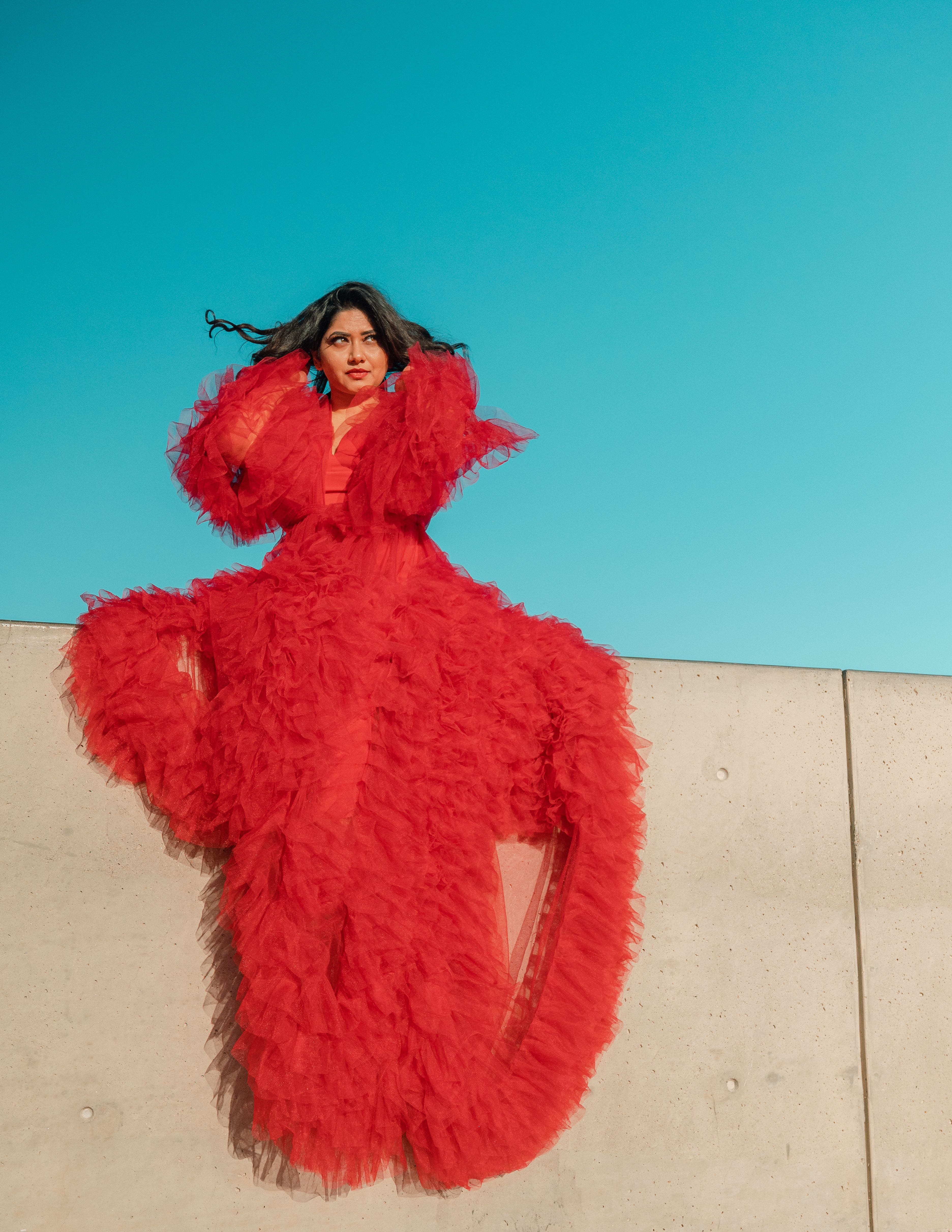 Woman in Red Dress Sitting on Concrete · Free Stock Photo