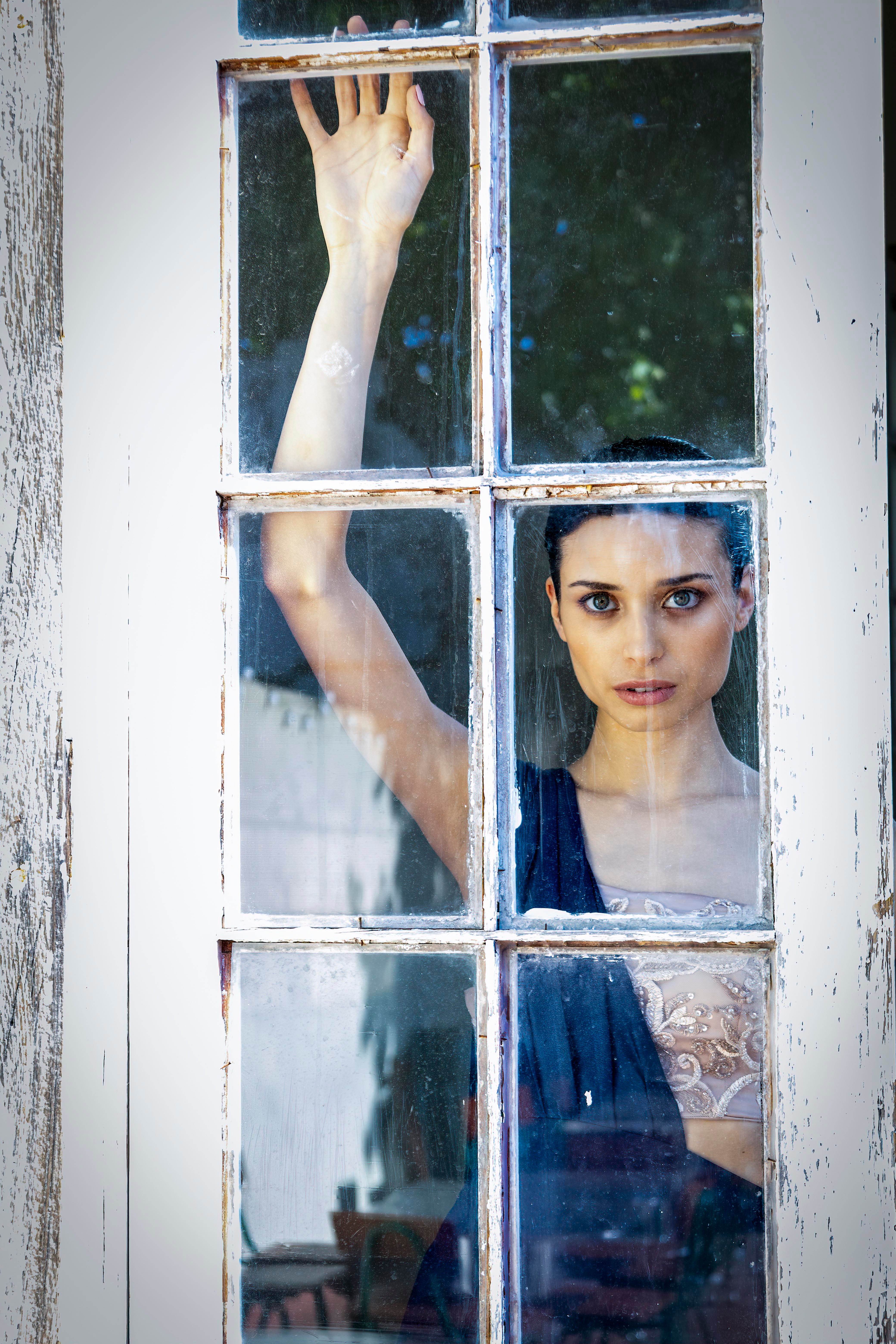 Woman Posing on the Glass Window · Free Stock Photo