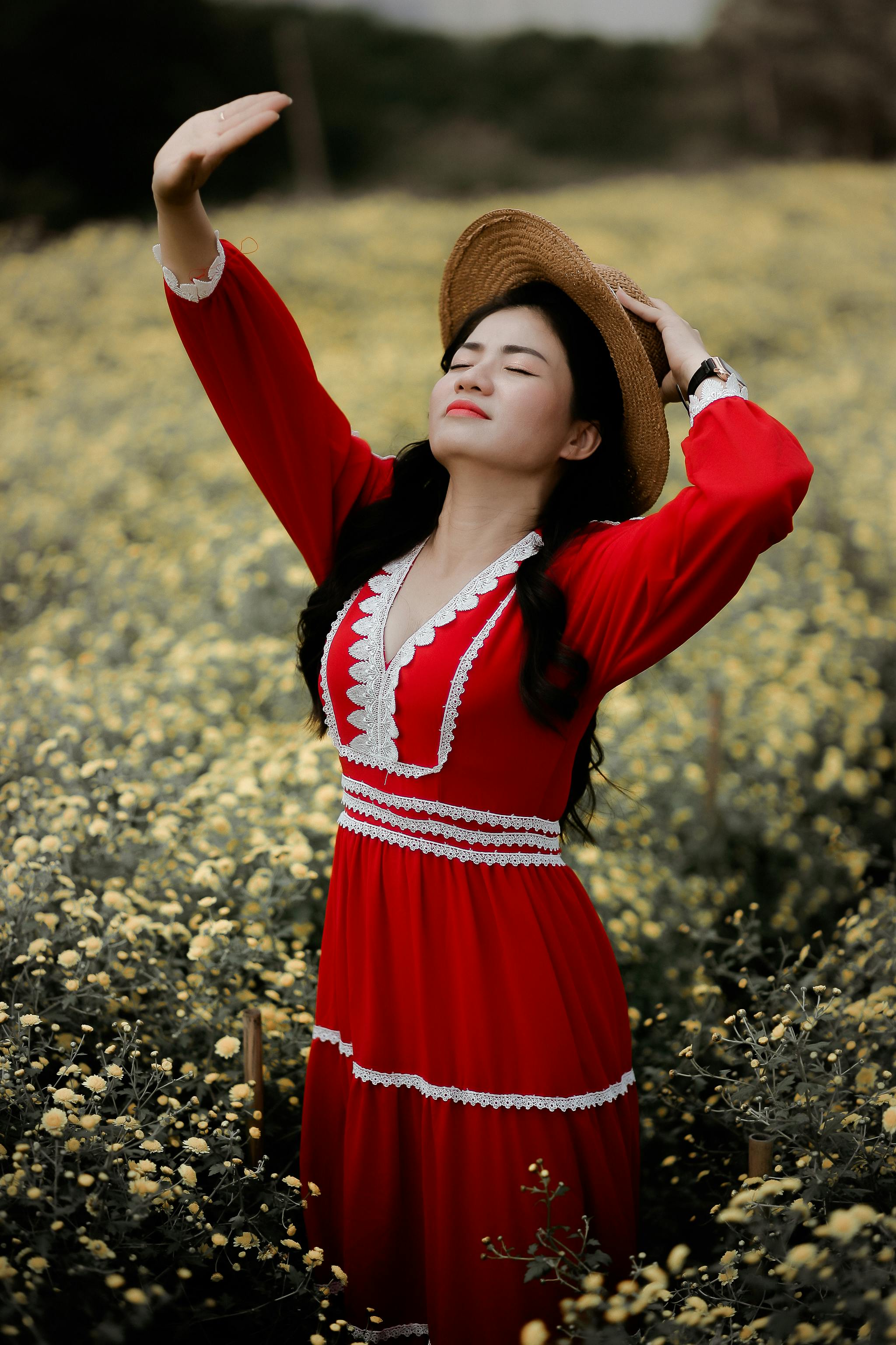 Photo of Woman in White Dress Posing with Her Head up and Her Hands ...