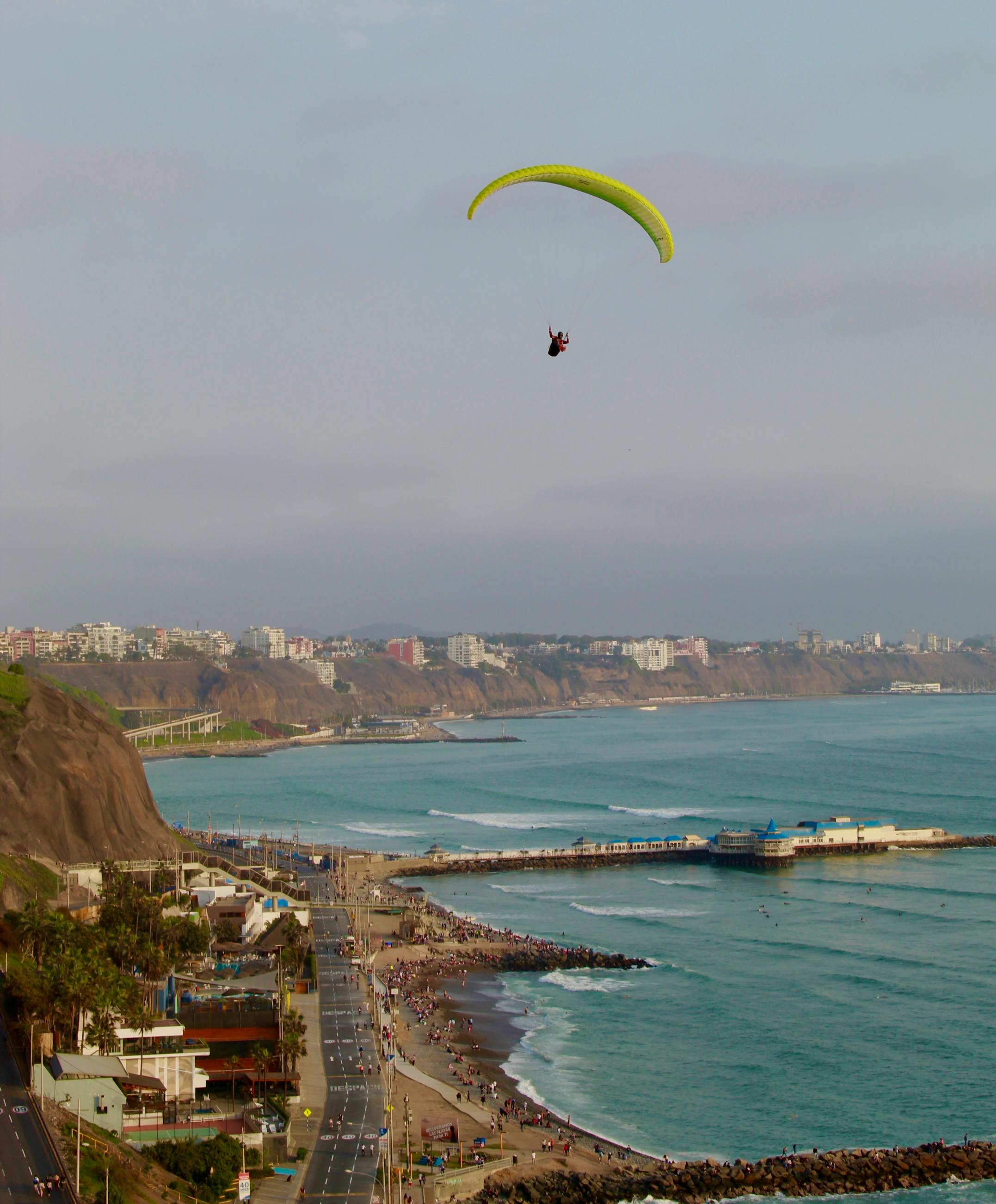 Parachuting over Sea Coast · Free Stock Photo