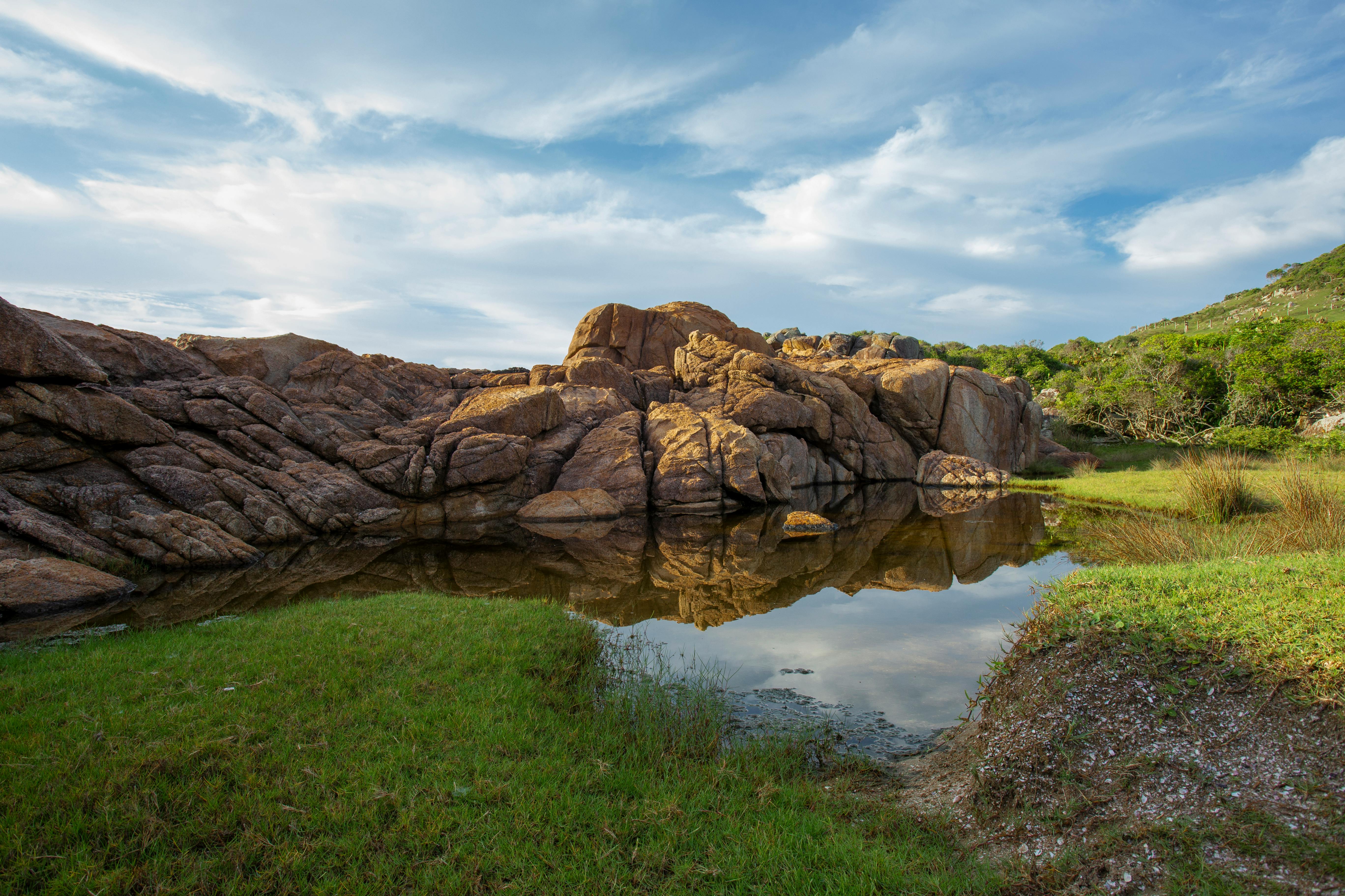 Rocks Formation Reflection over Water · Free Stock Photo