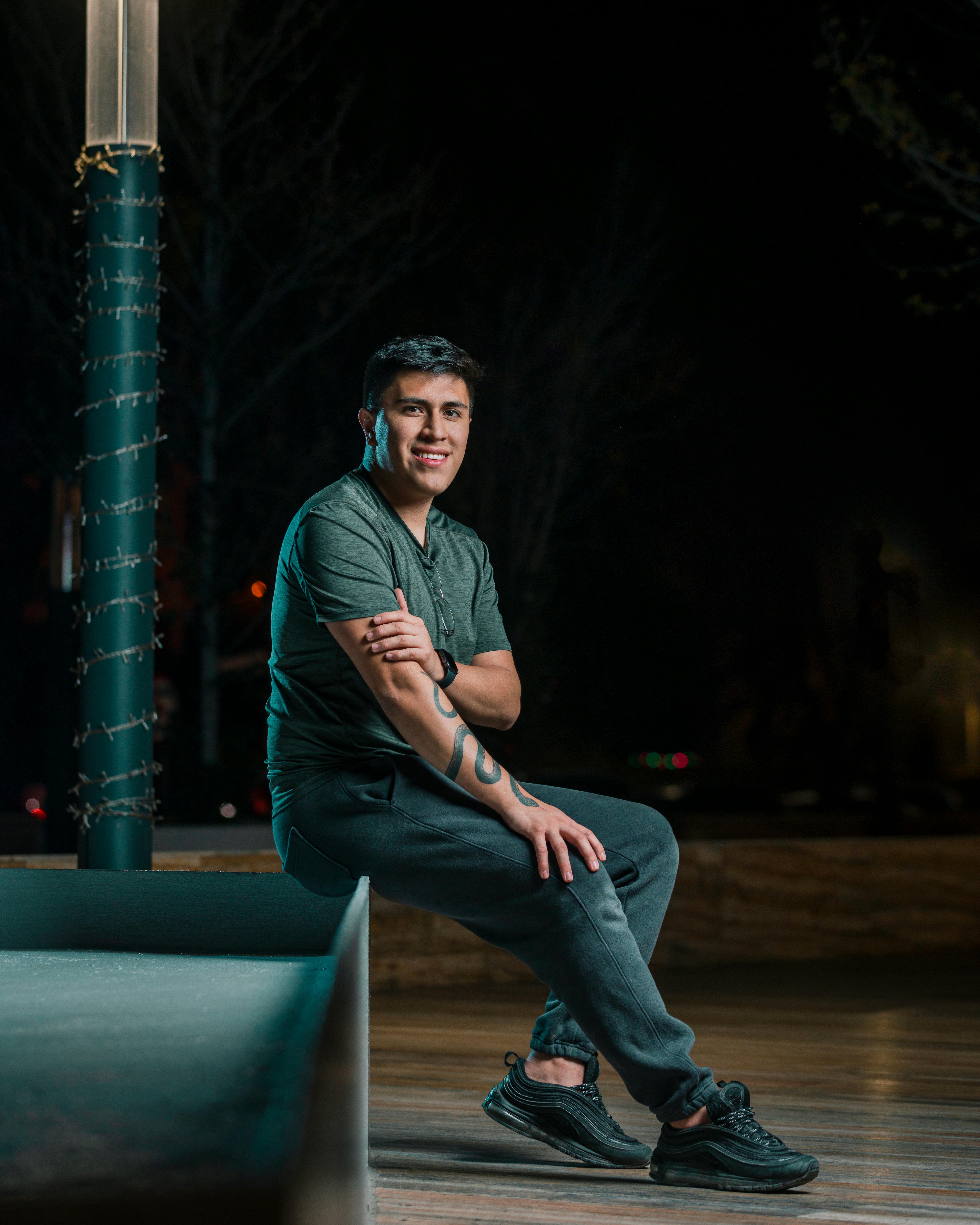 Man Sitting near a Post · Free Stock Photo