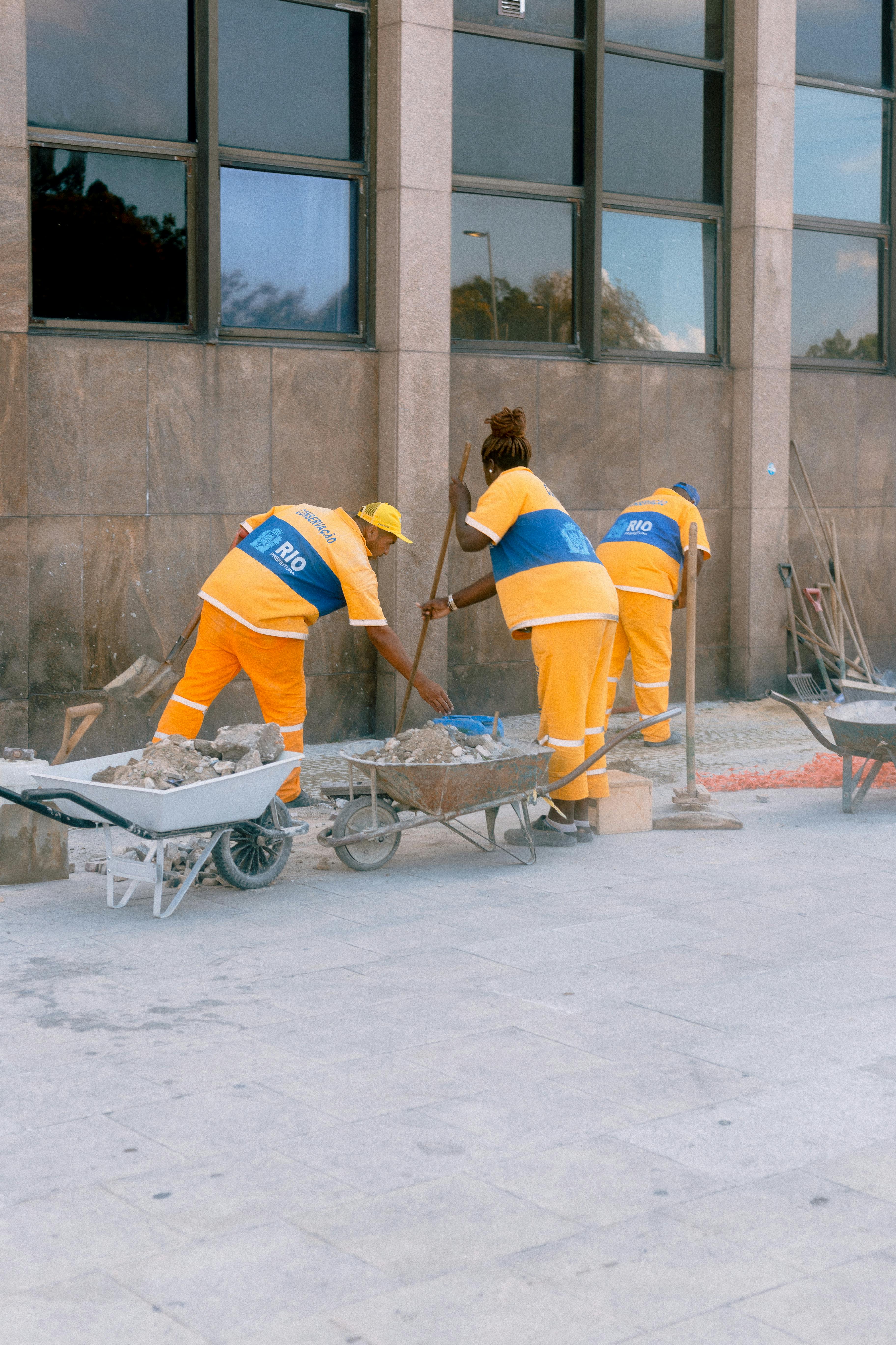 Construction Workers Cleaning the Side of the Building · Free Stock Photo