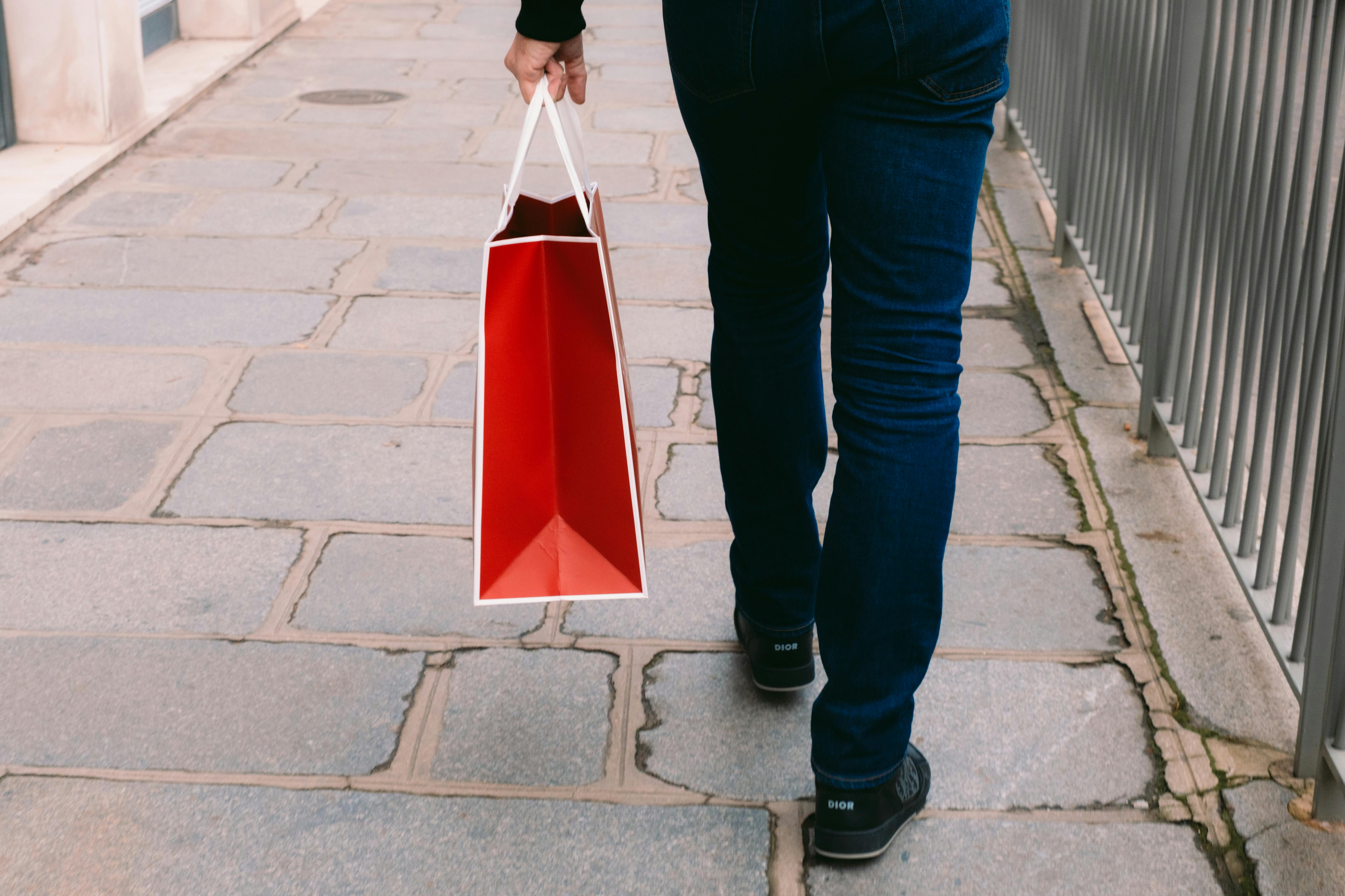 A Person Walking While Carrying Shopping Bags · Free Stock Photo