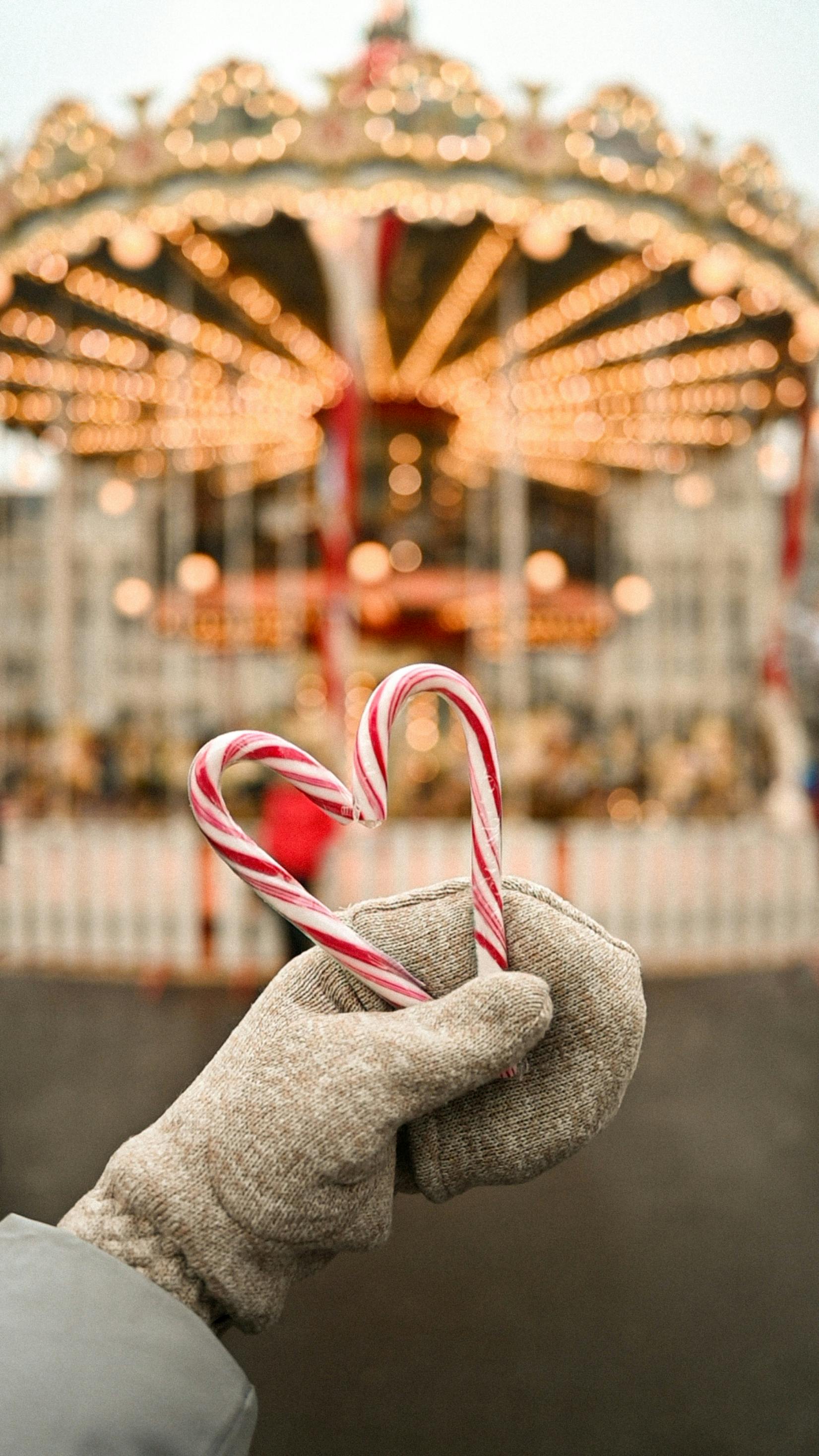 Person Holding Candy Canes Forming Heart Shape · Free Stock Photo