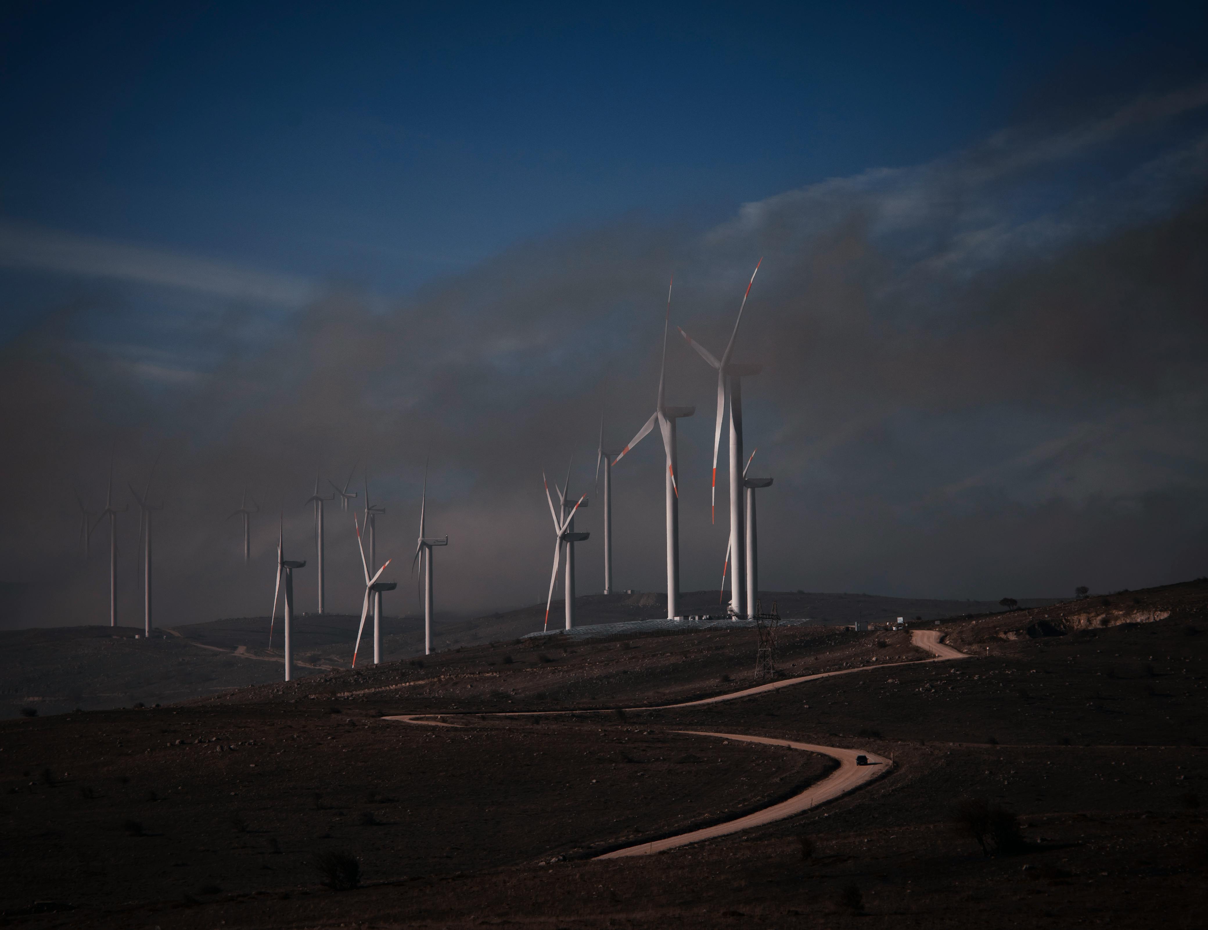 People Walking on Hill with Wind Turbines · Free Stock Photo