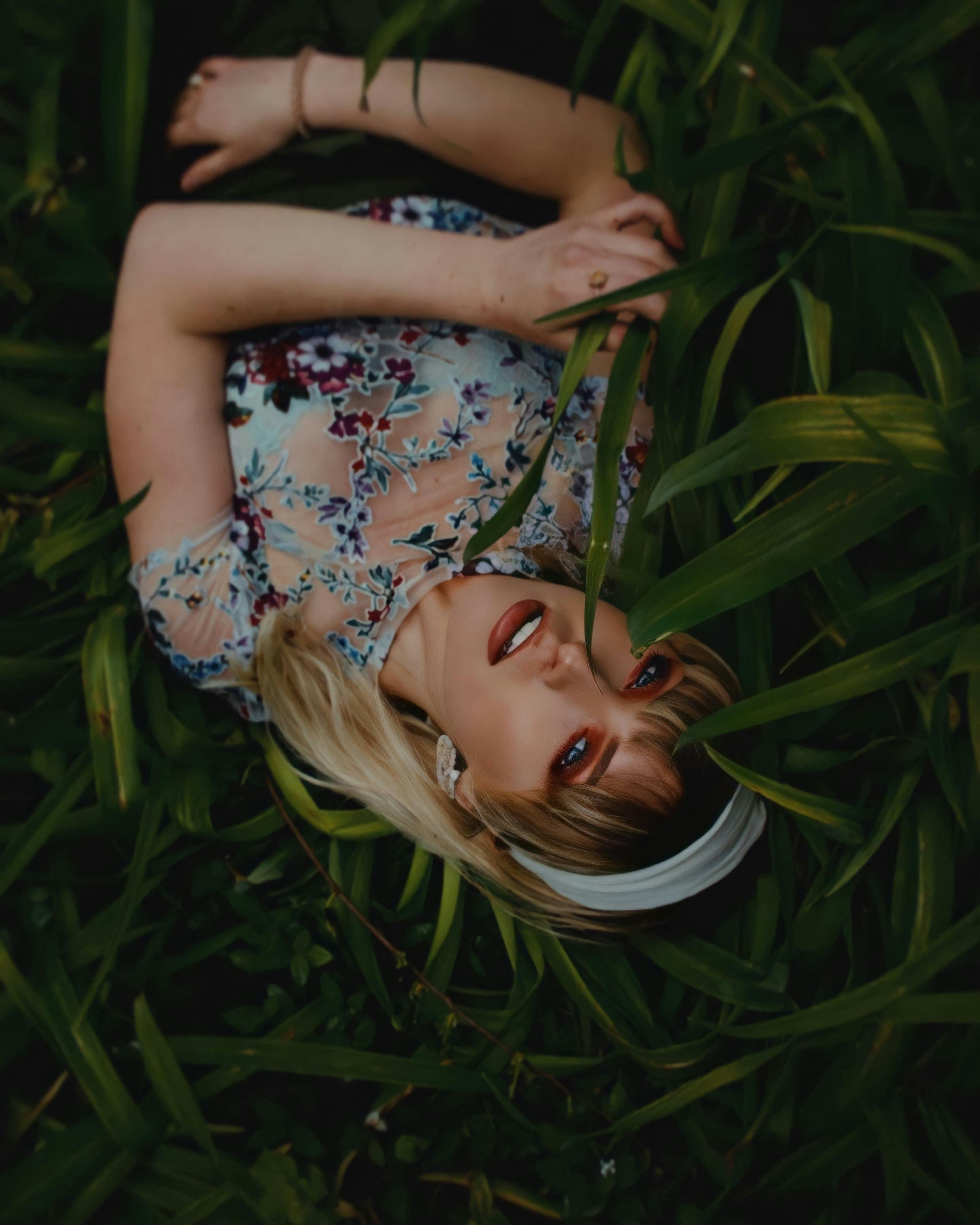 Portrait of a Female Model Lying in the Grass · Free Stock Photo