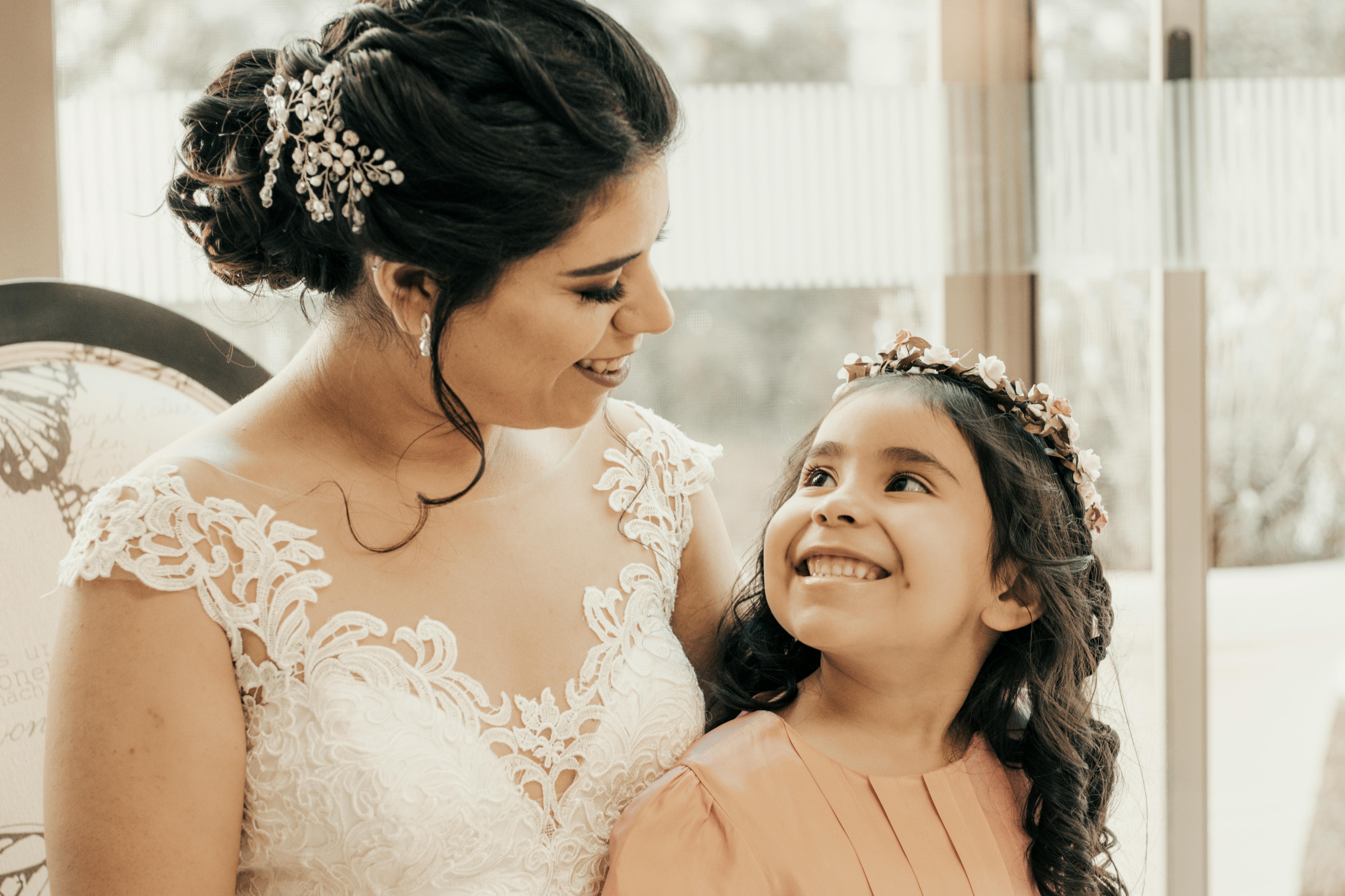A Beautiful Bride Smiling while Looking at Her Daughter · Free Stock Photo