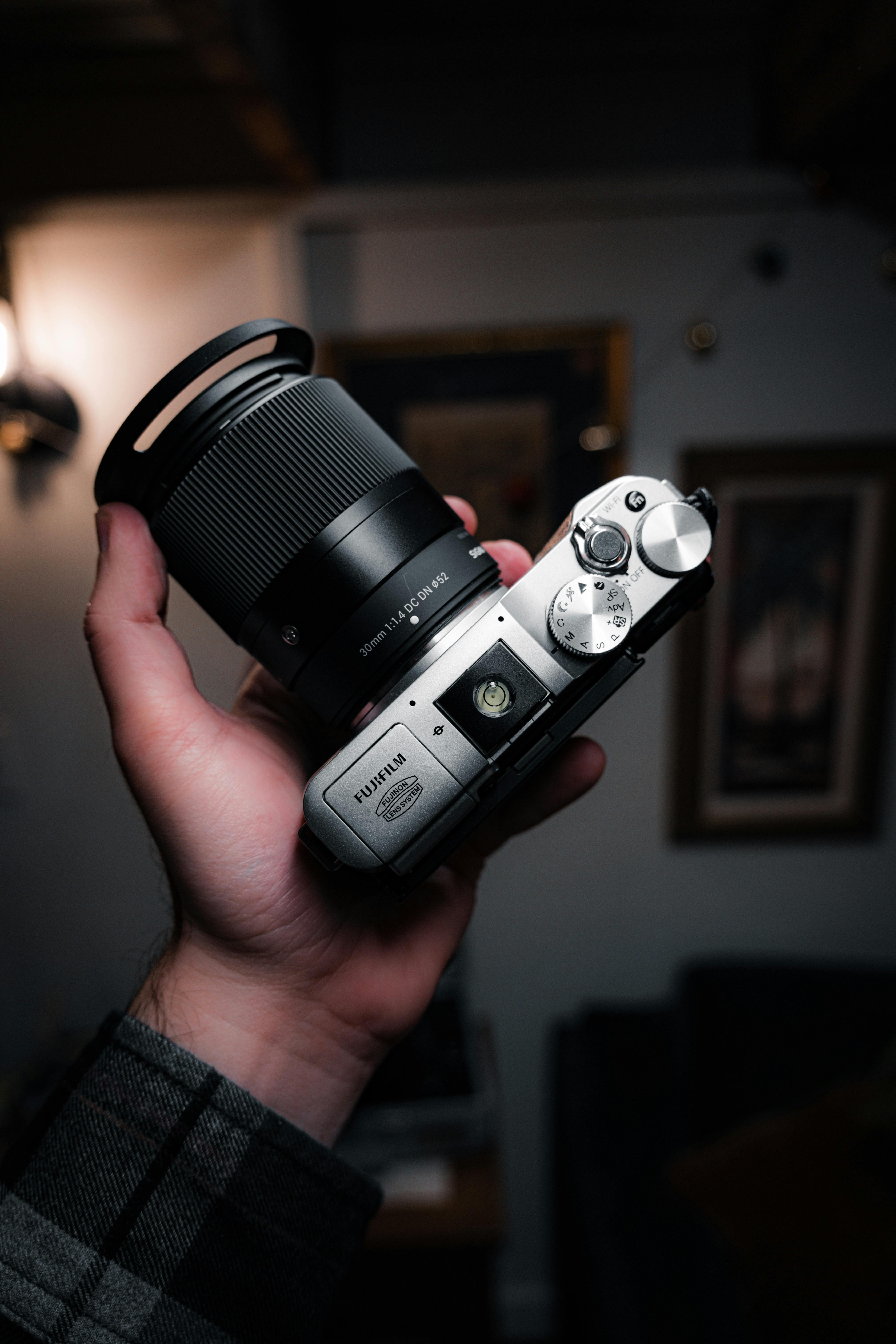A person holding a camera in their hand · Free Stock Photo