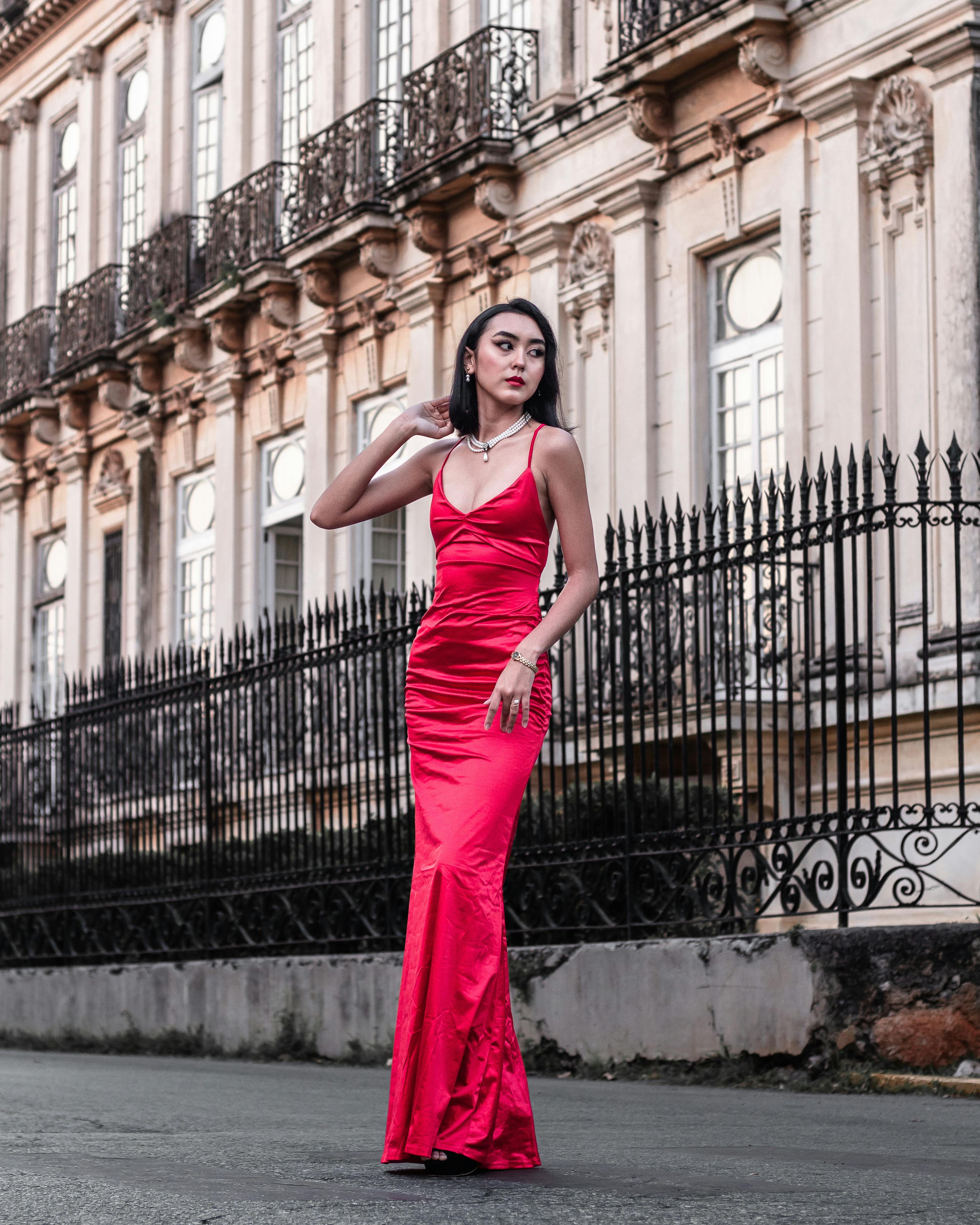 A Woman in Red Dress Standing on the Street · Free Stock Photo