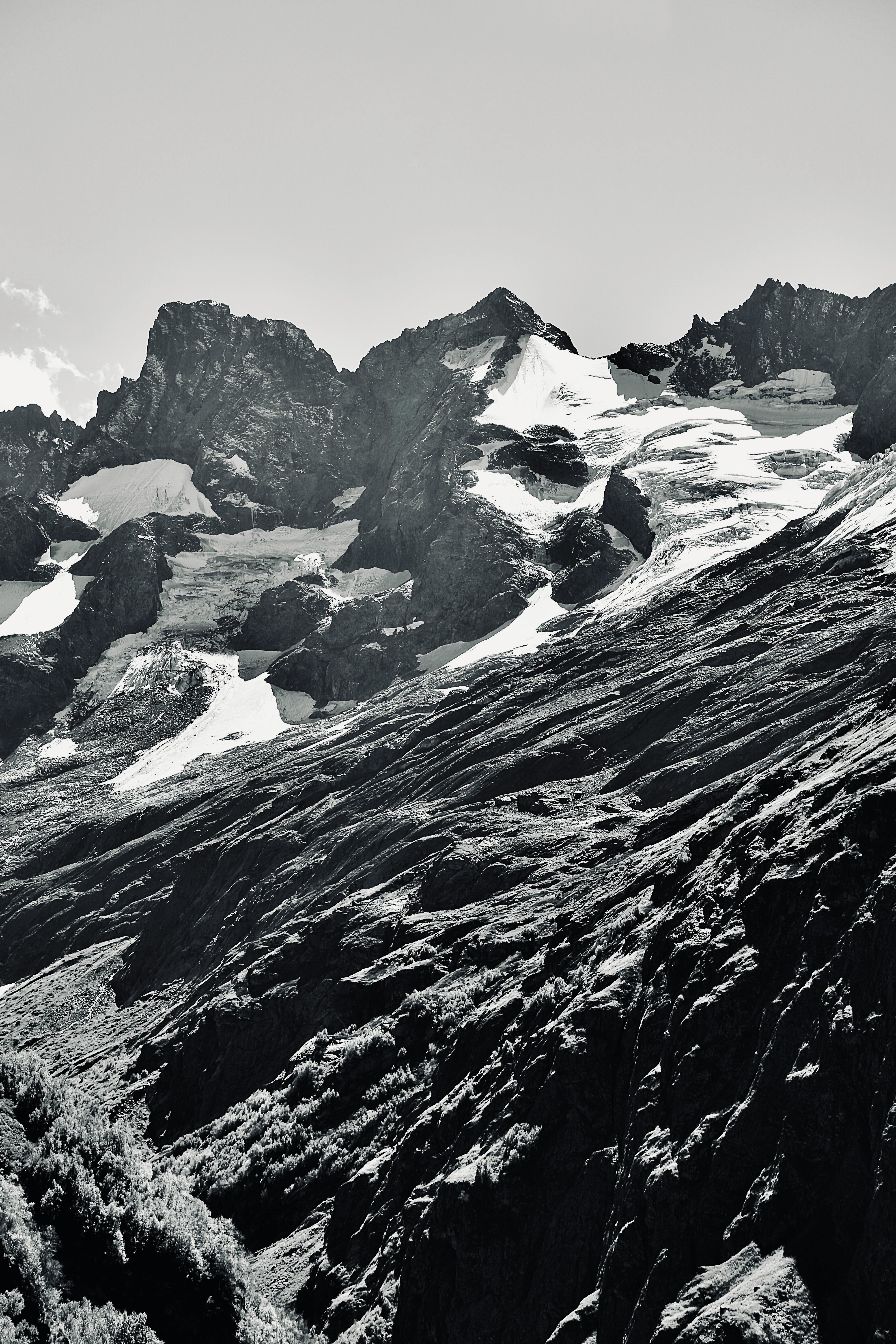 A Grayscale Photo of a Snow Covered Mountain · Free Stock Photo