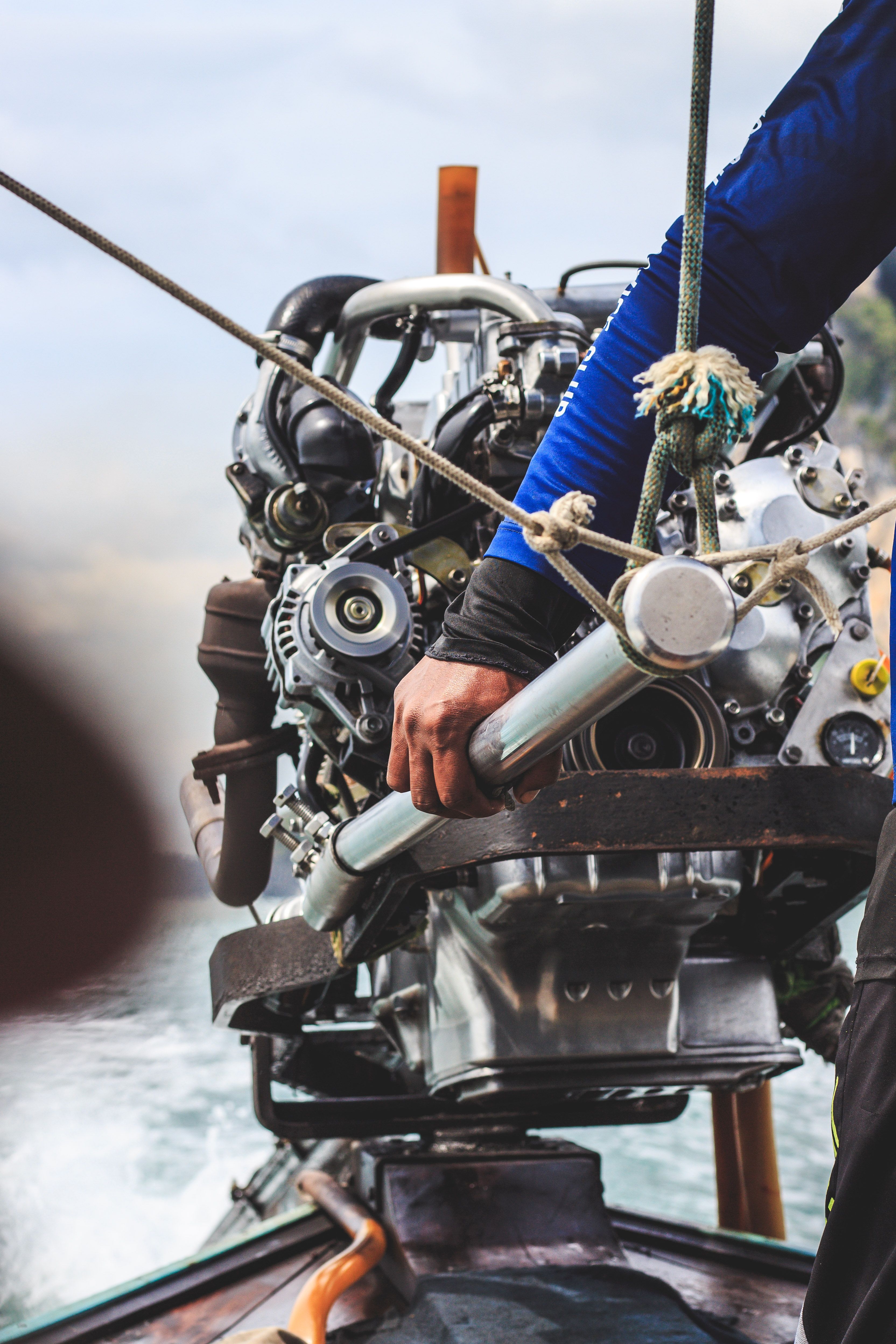 Man with a Large Engine in a Workshop · Free Stock Photo