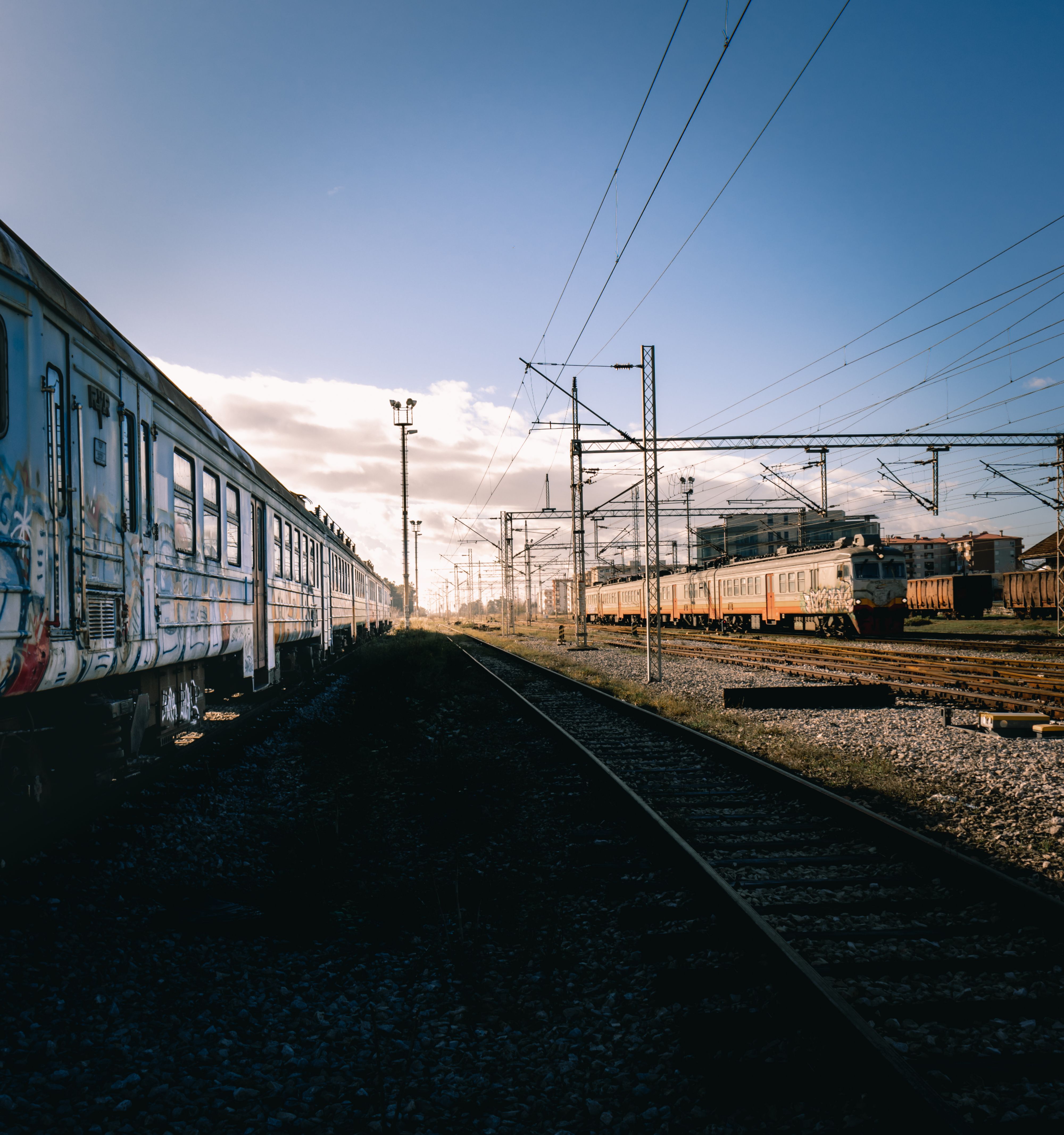 Blue Train on Train Tracks under Blue Sky · Free Stock Photo