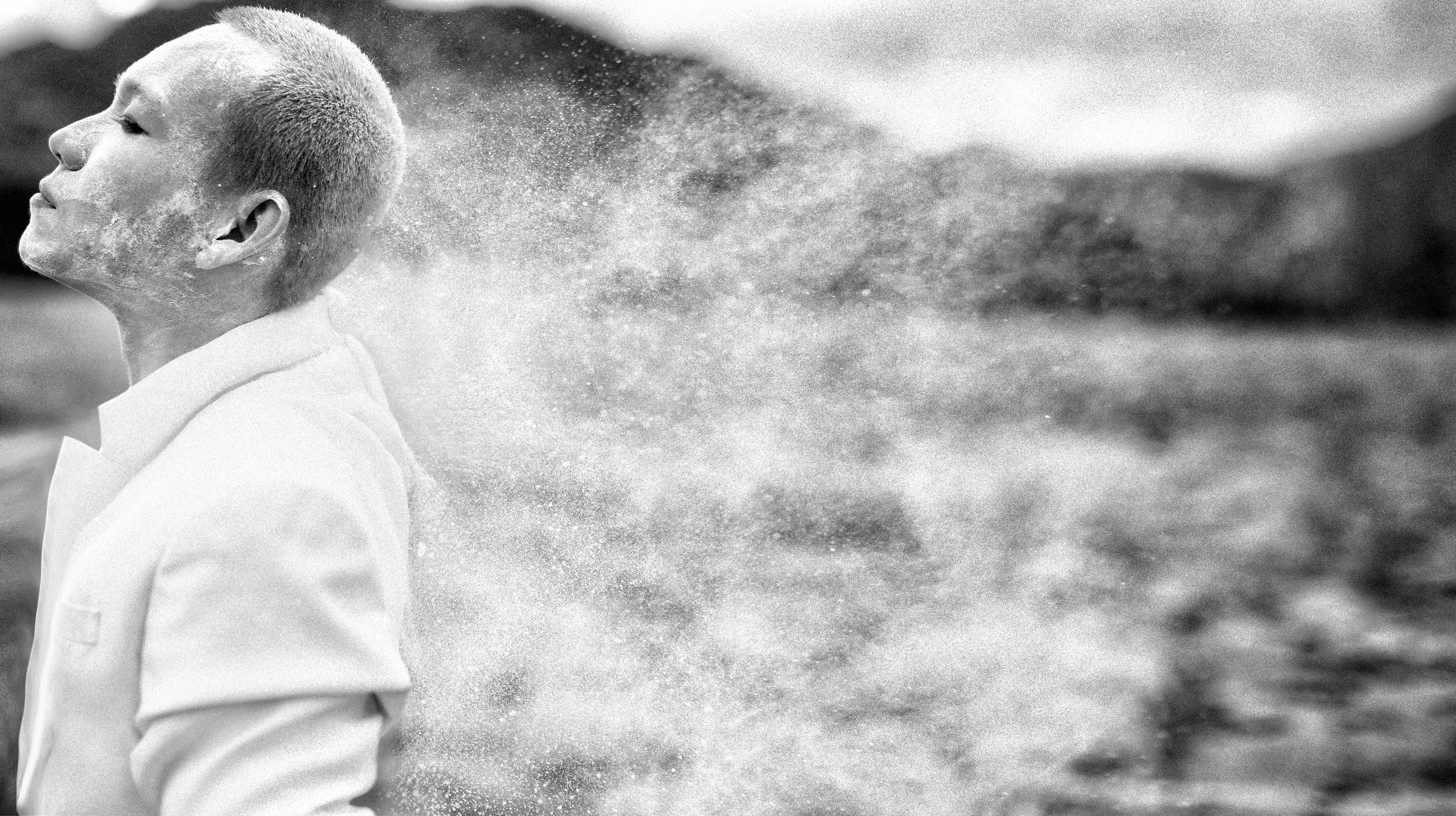 Black and White Photo of Dust Blowing Past Person · Free Stock Photo