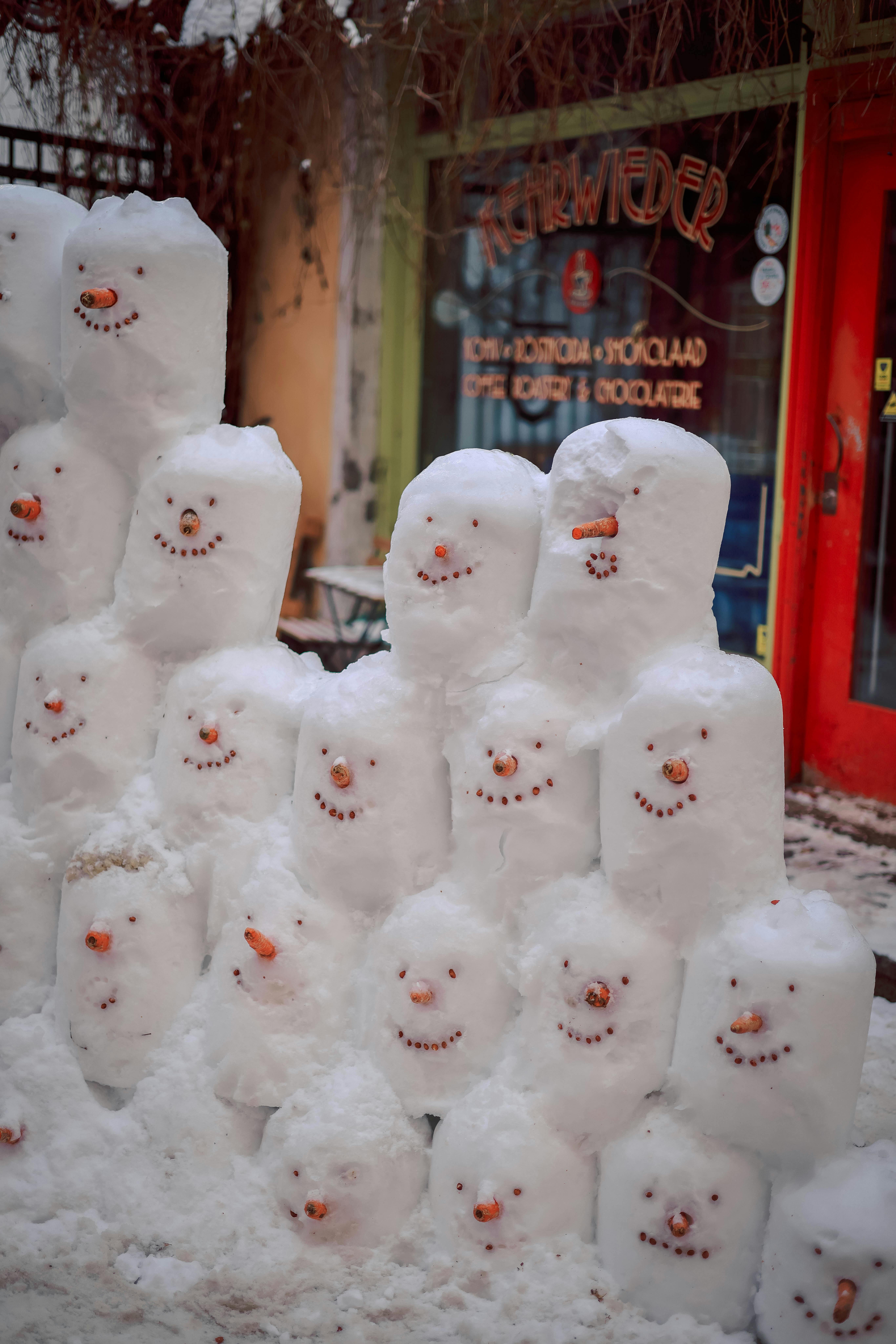 Stacked Snowmens Heads in front of Store Entrance · Free Stock Photo
