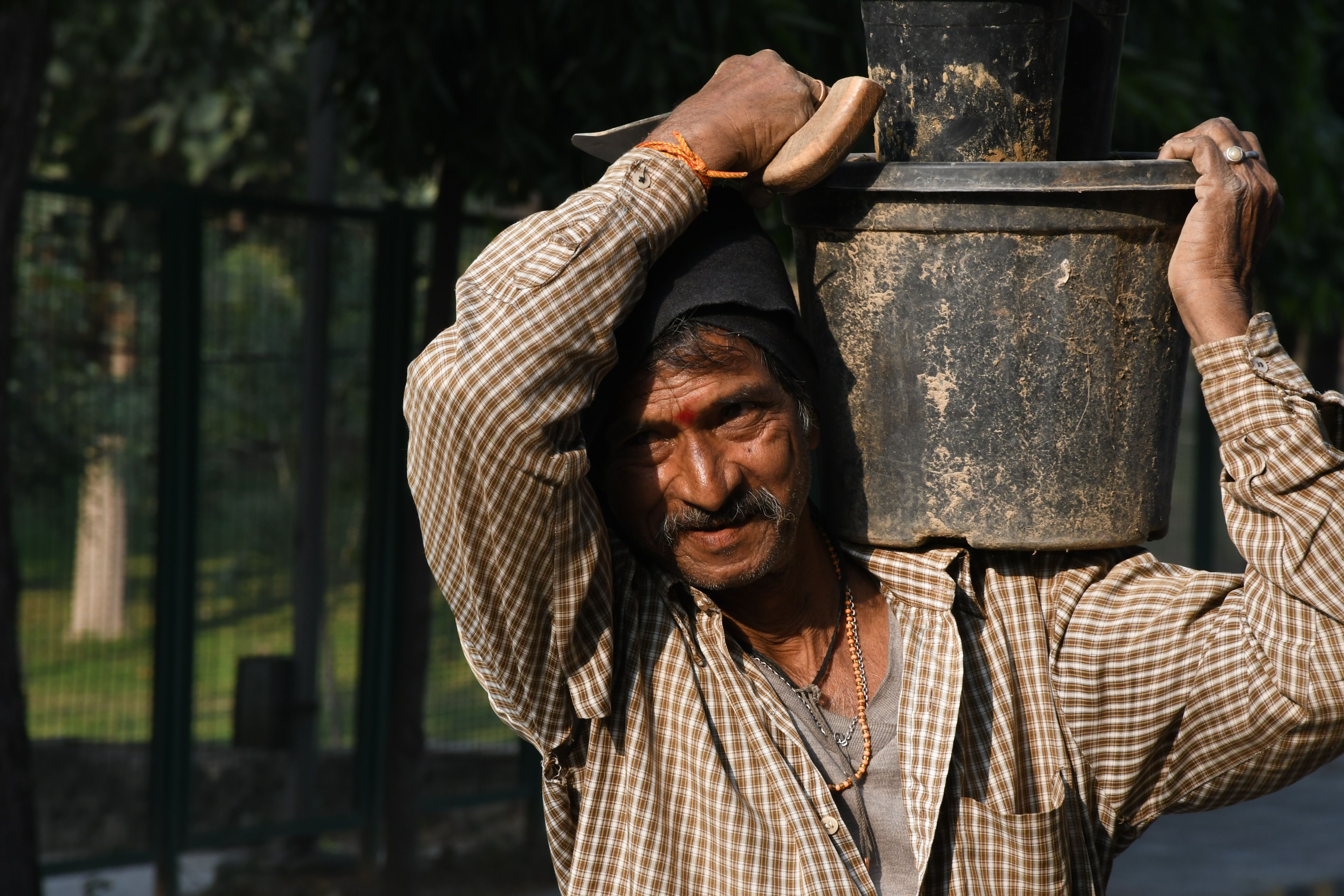 A Man Carrying a Bucket · Free Stock Photo