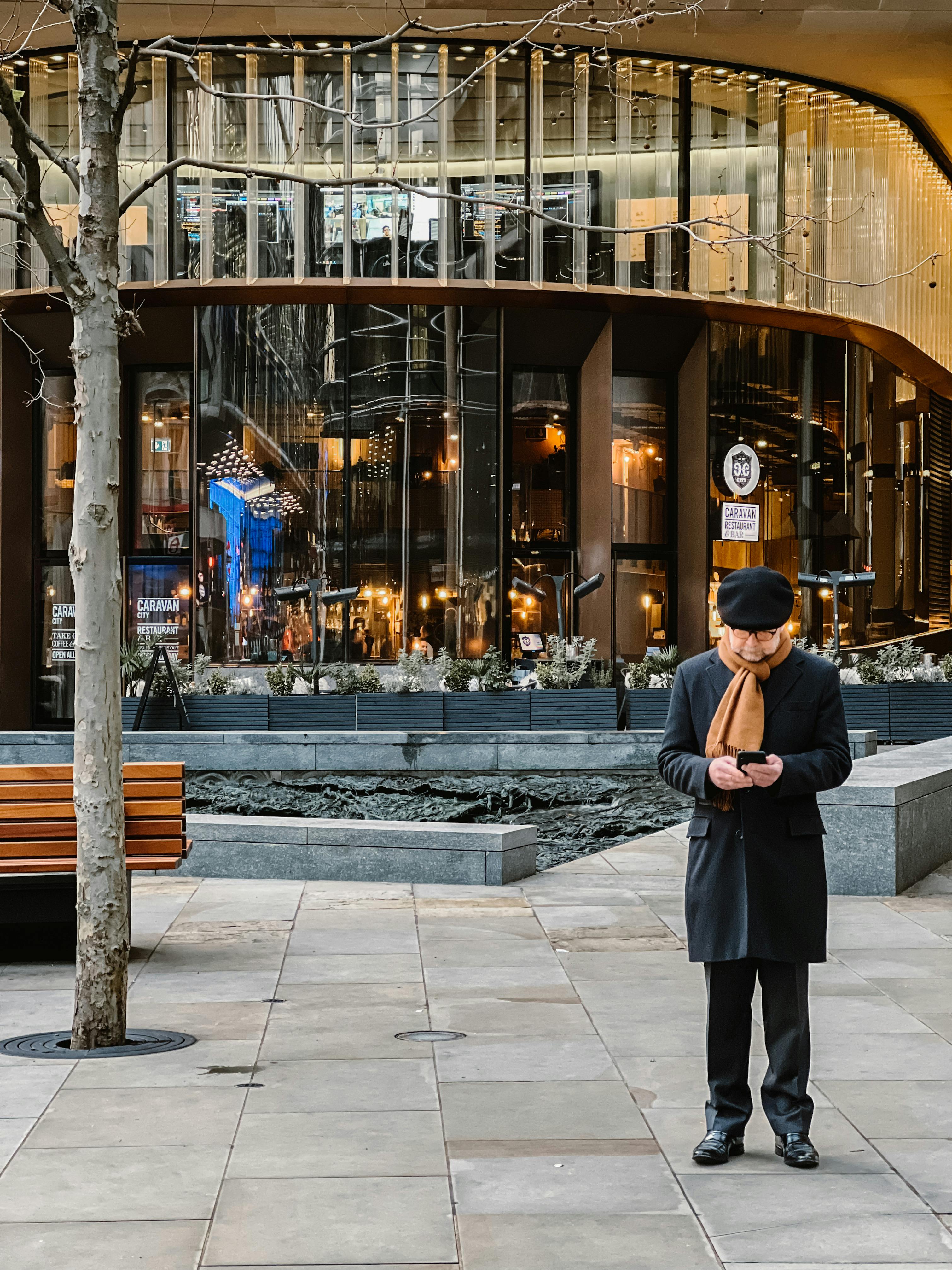 Elegant Man Standing on the Sidewalk in front of a Shopping Mall · Free ...