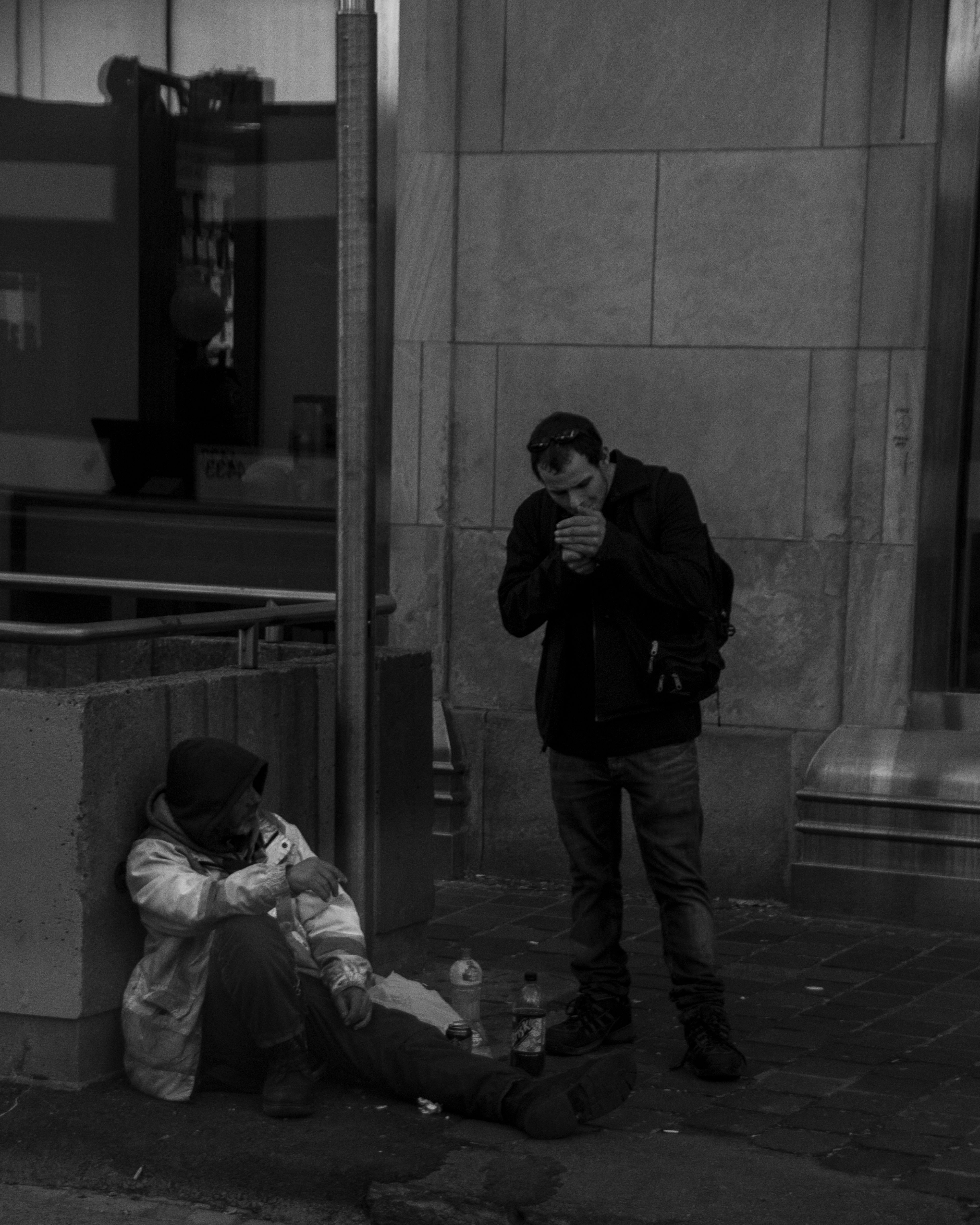 Men Sitting on a Sidewalk and Smoking a Cigarette · Free Stock Photo