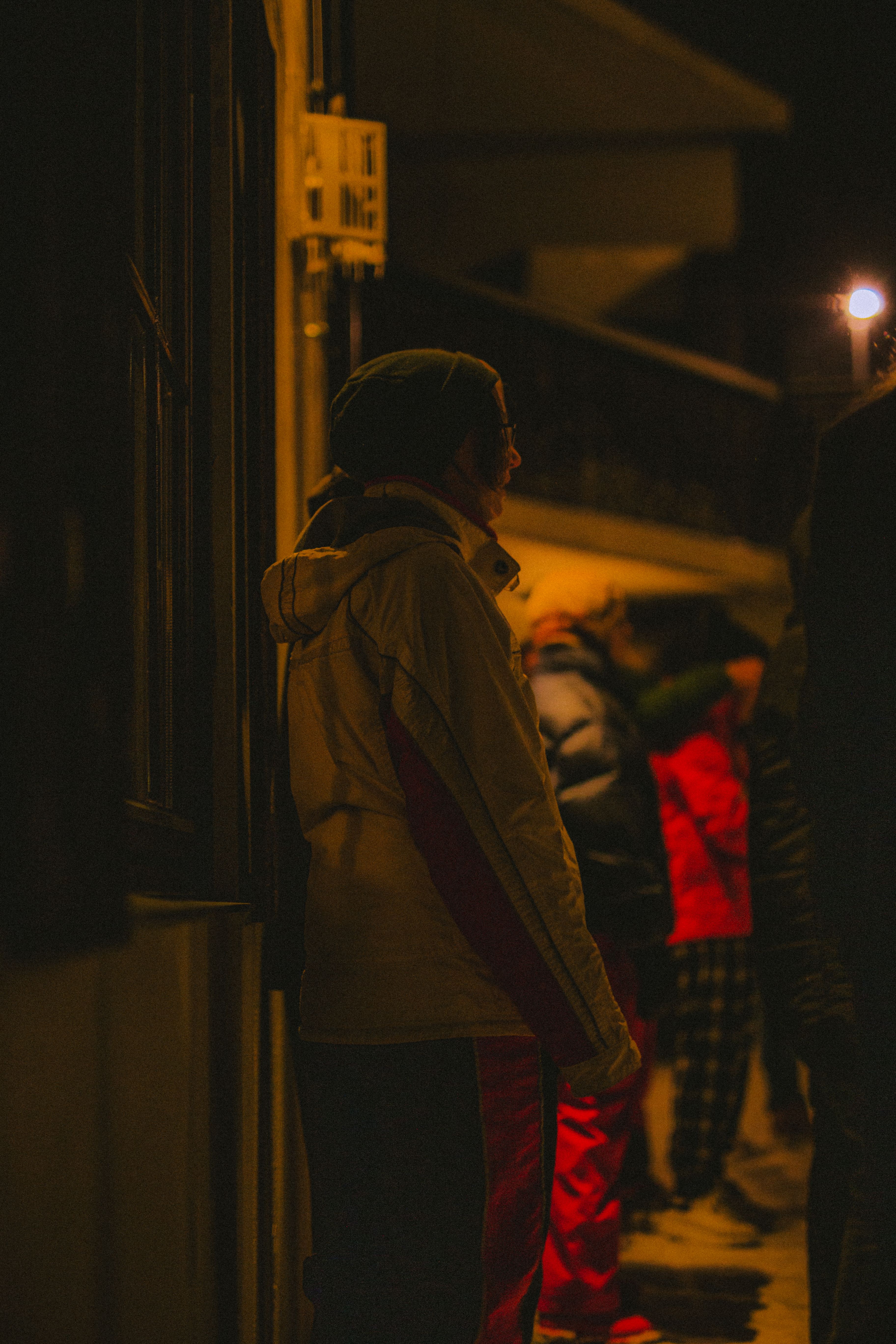 People Wearing Winter Clothes Standing Outside a House · Free Stock Photo