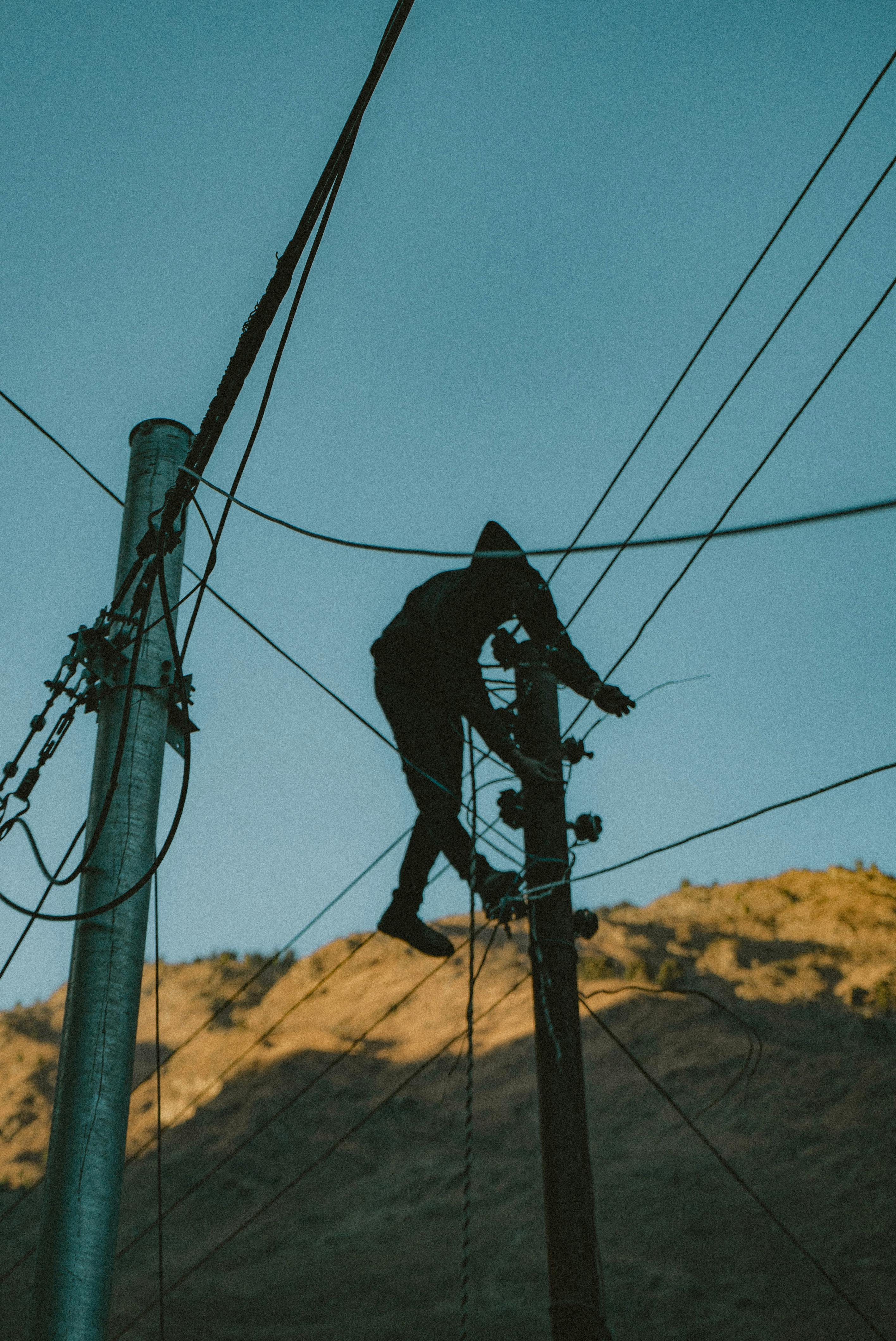 Man on Power Lines · Free Stock Photo