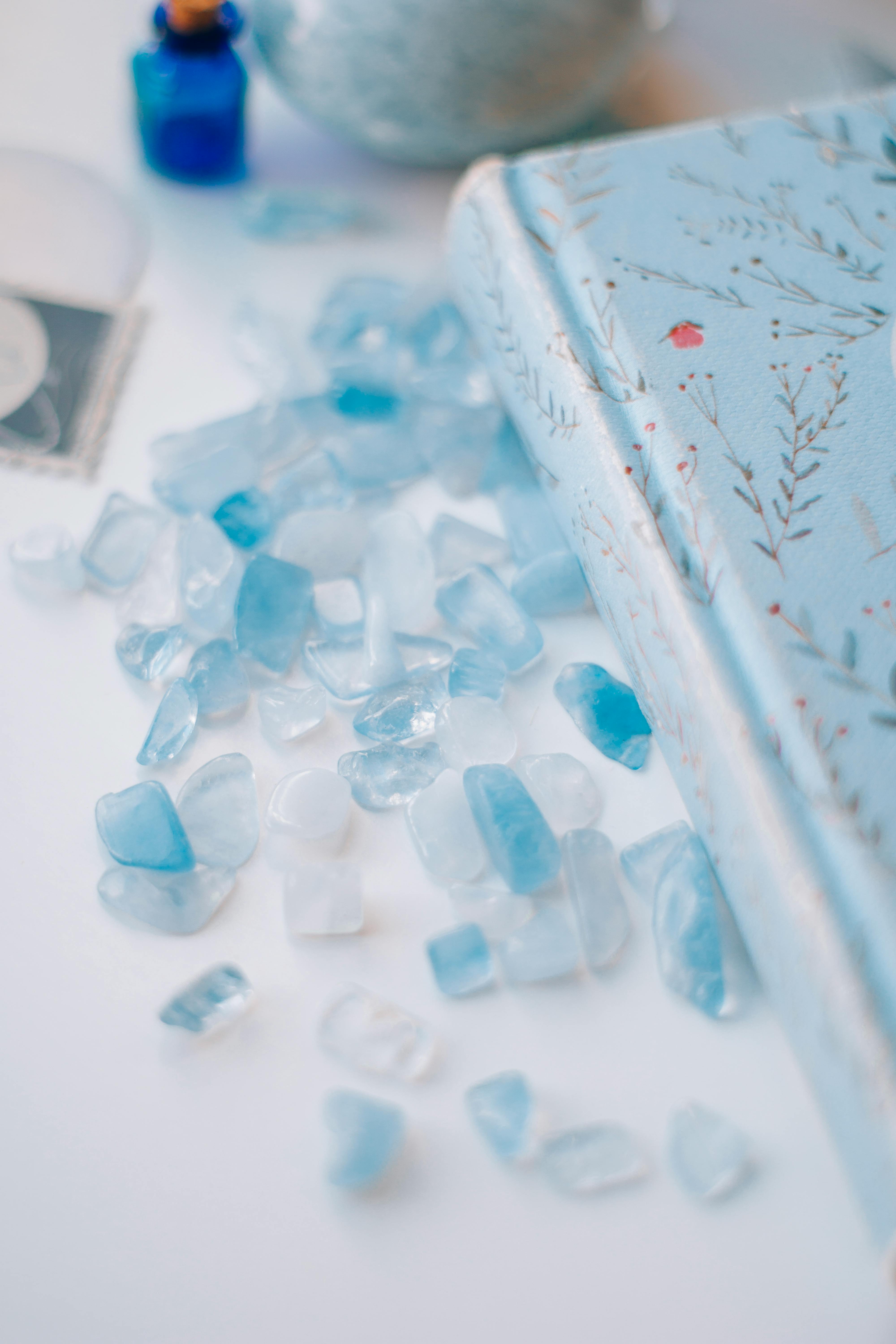 Close-up of Light Blue Crystals Scattered on a Desk · Free Stock Photo