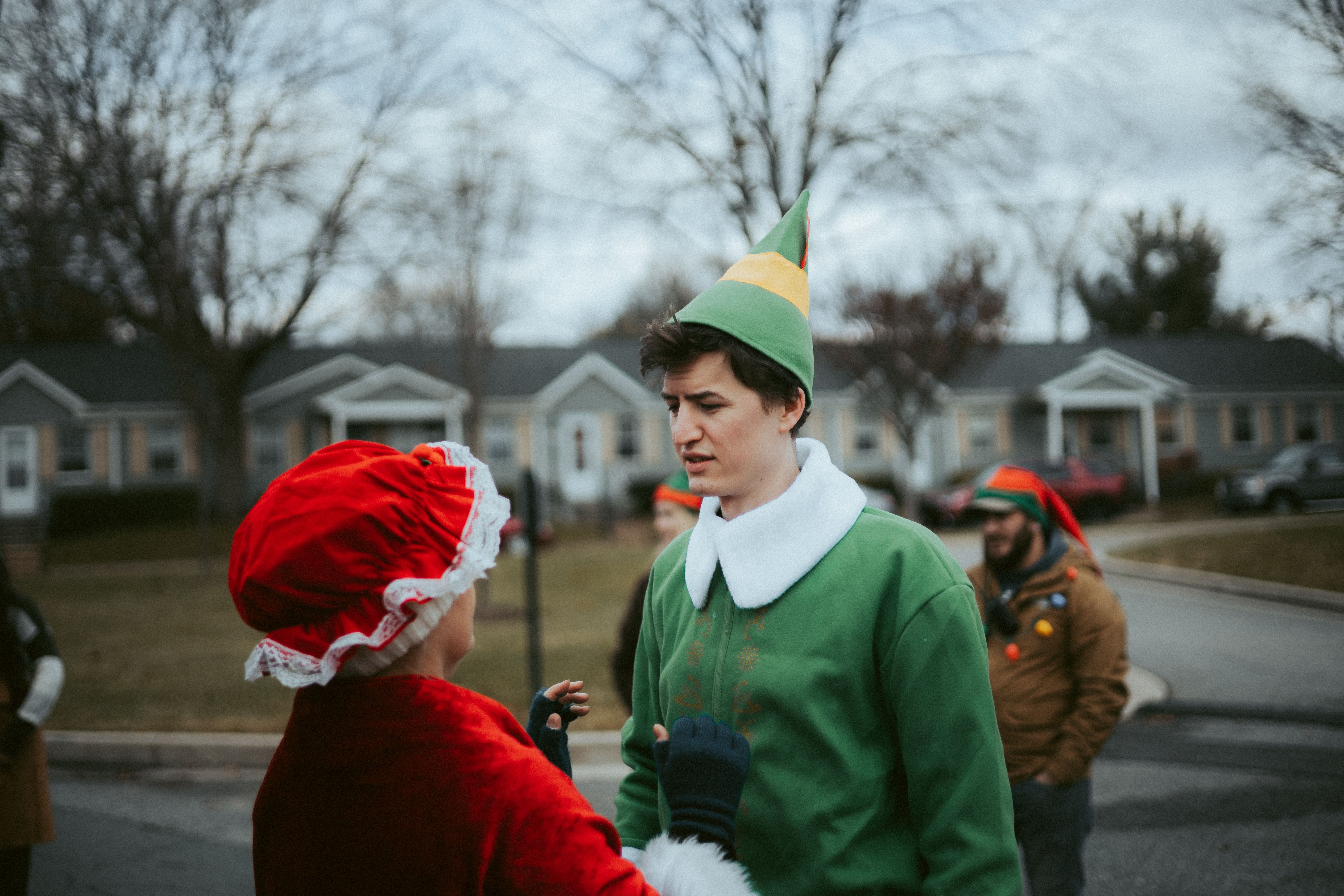 Man in Elf Costume Standing in Front of Woman in Red Costume · Free ...