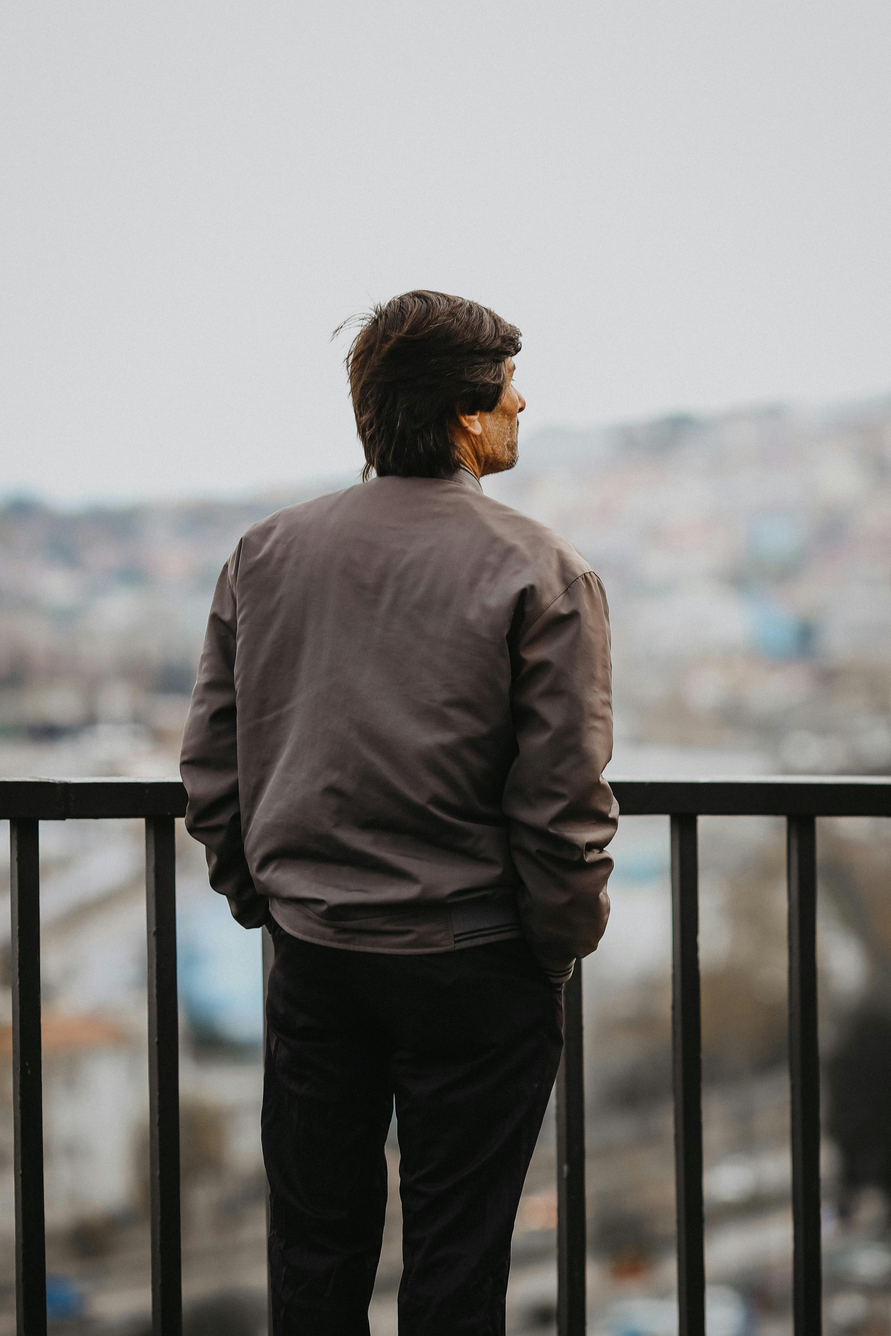 Person Leaning on Railing · Free Stock Photo