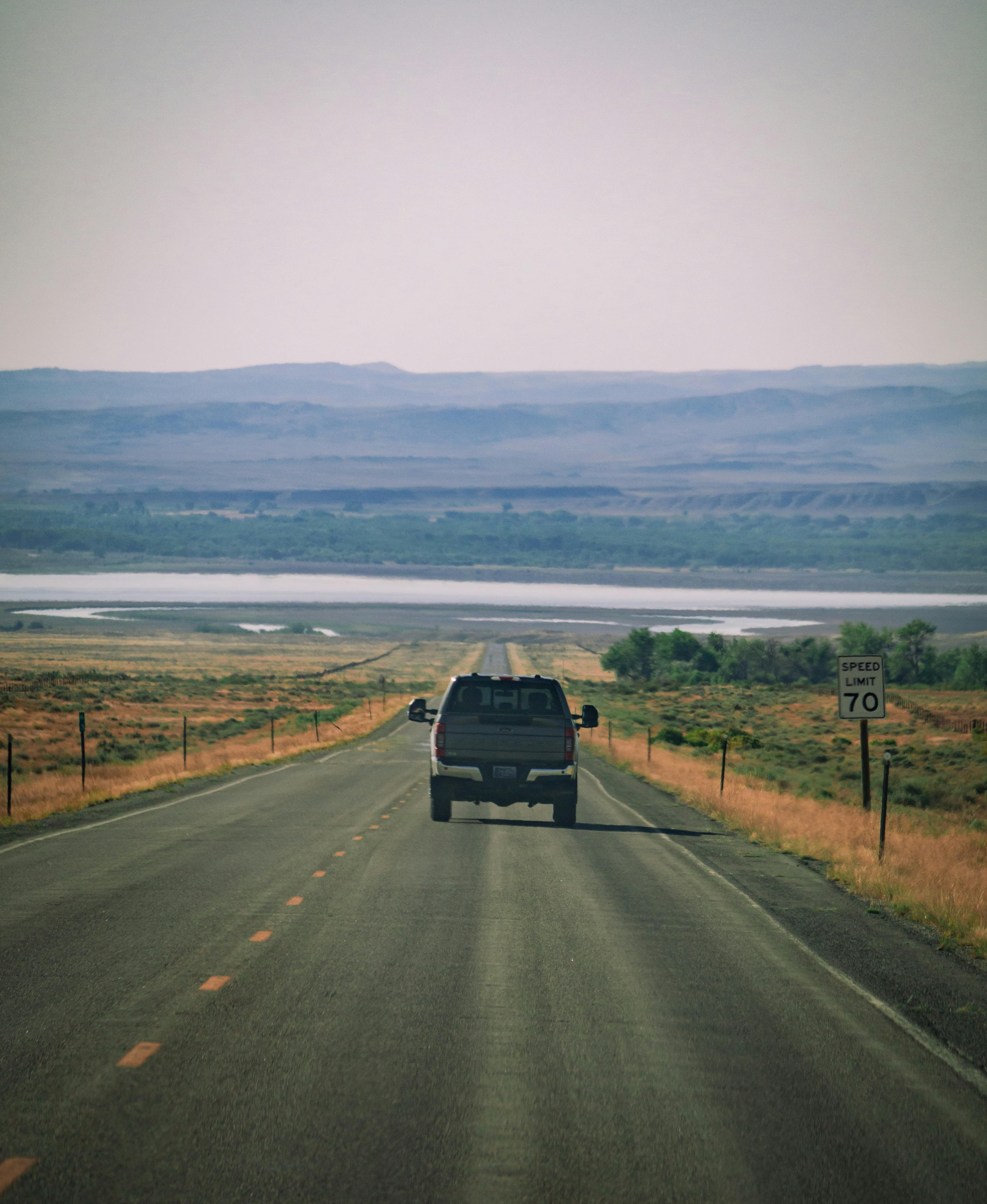 A Pickup Truck Travelling on a Road · Free Stock Photo