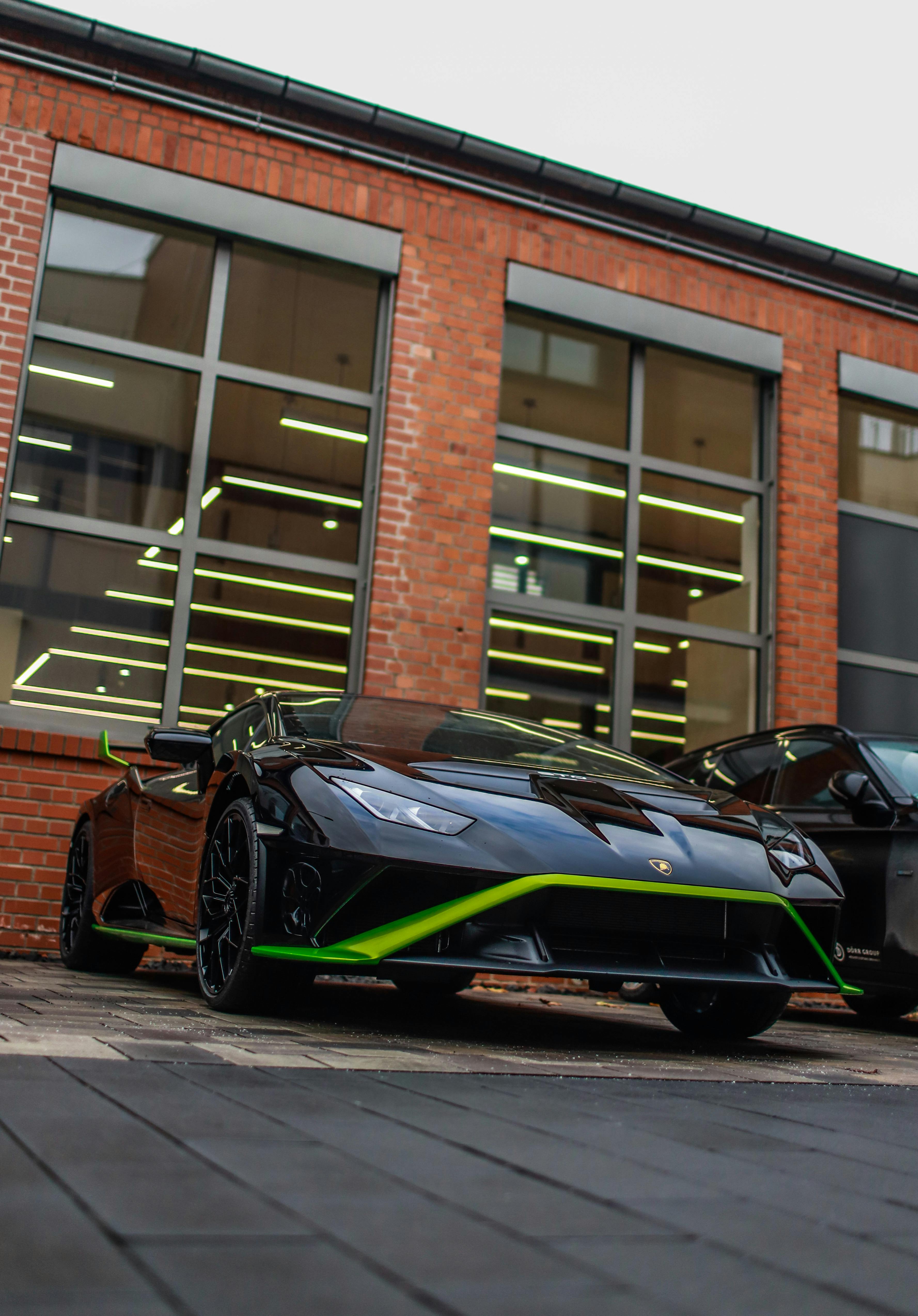 Green Lamborghini Parked on Gray Concrete Pavement · Free Stock Photo
